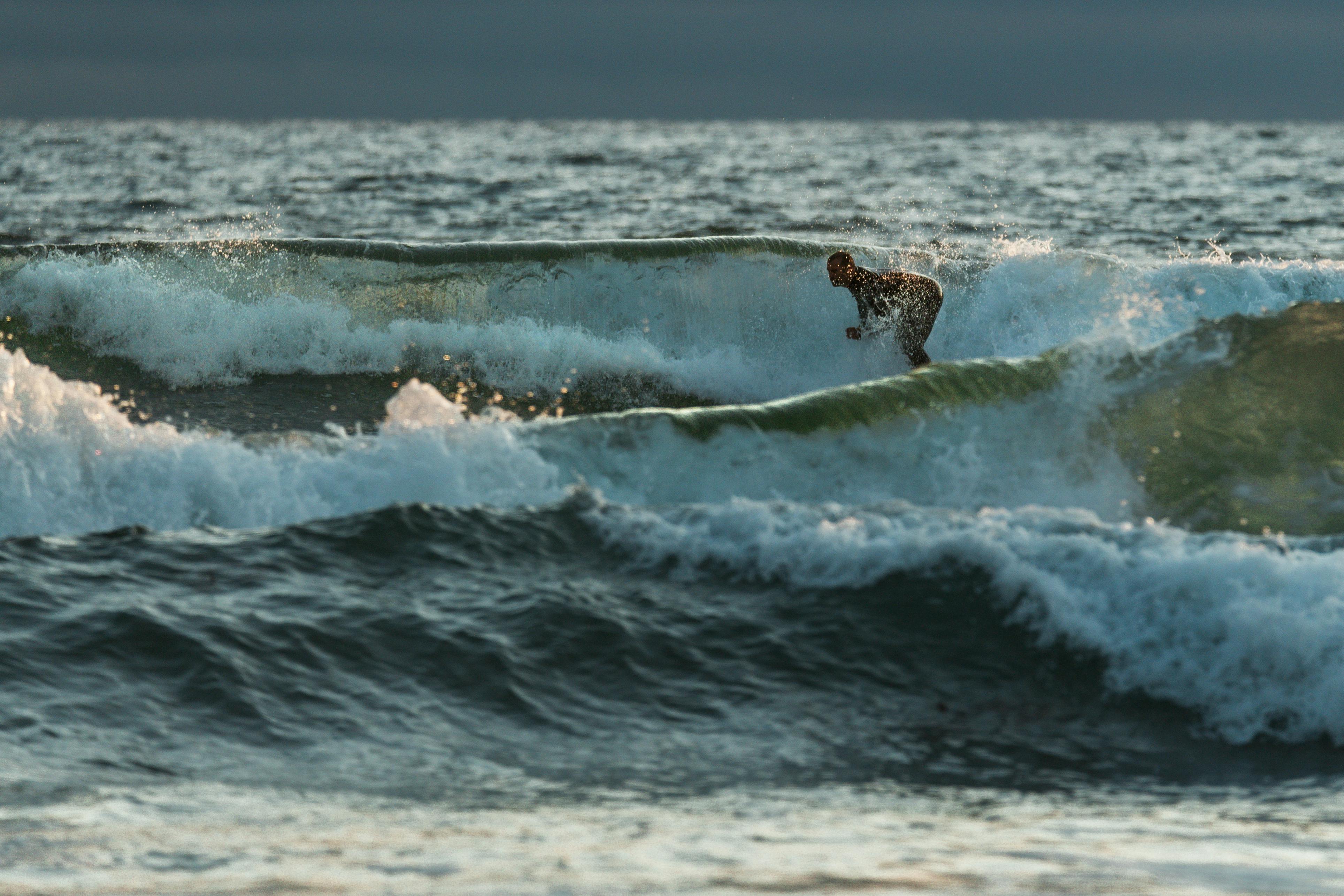People Surfing on Sea Waves · Free Stock Photo