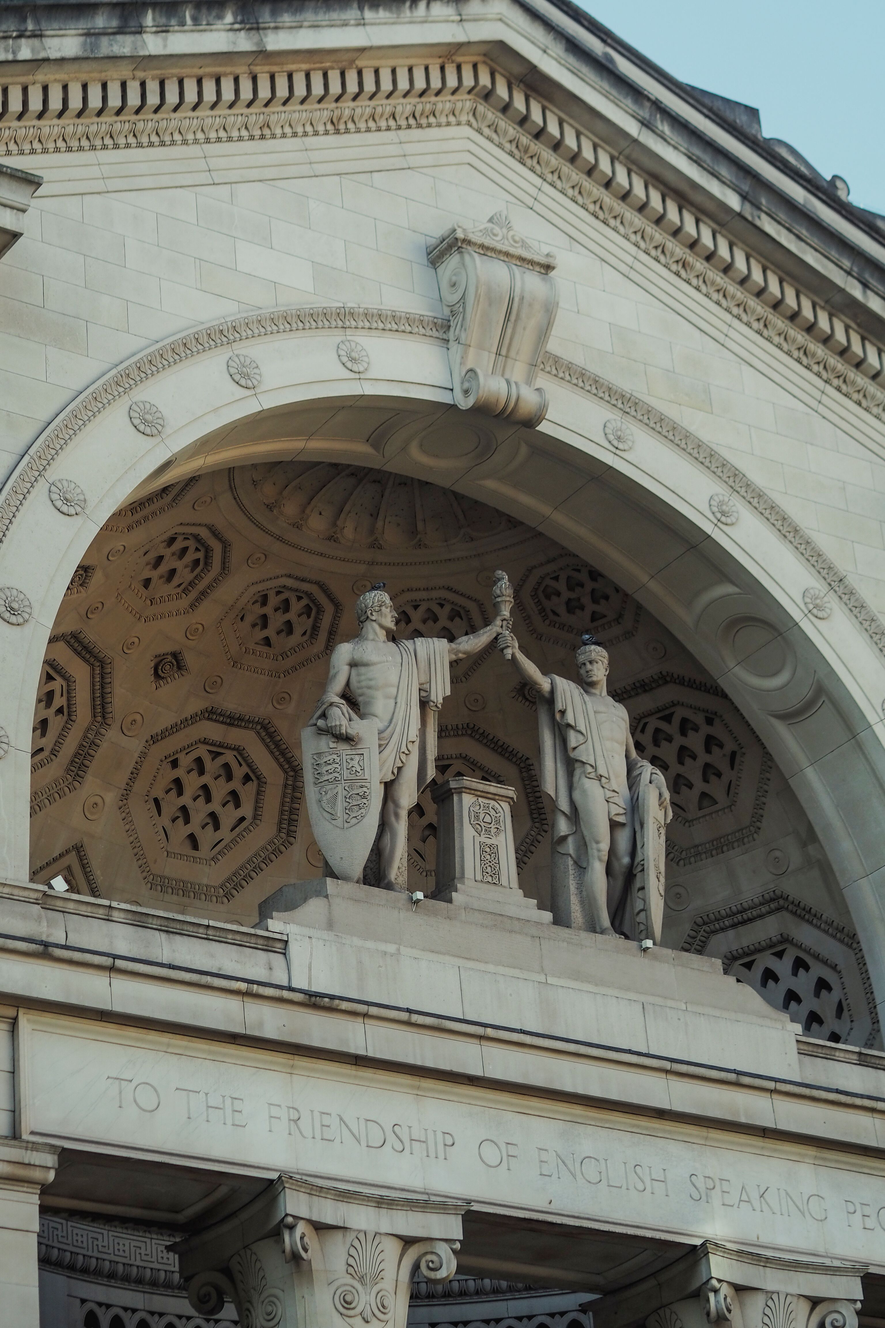 Statue on Building Wall · Free Stock Photo