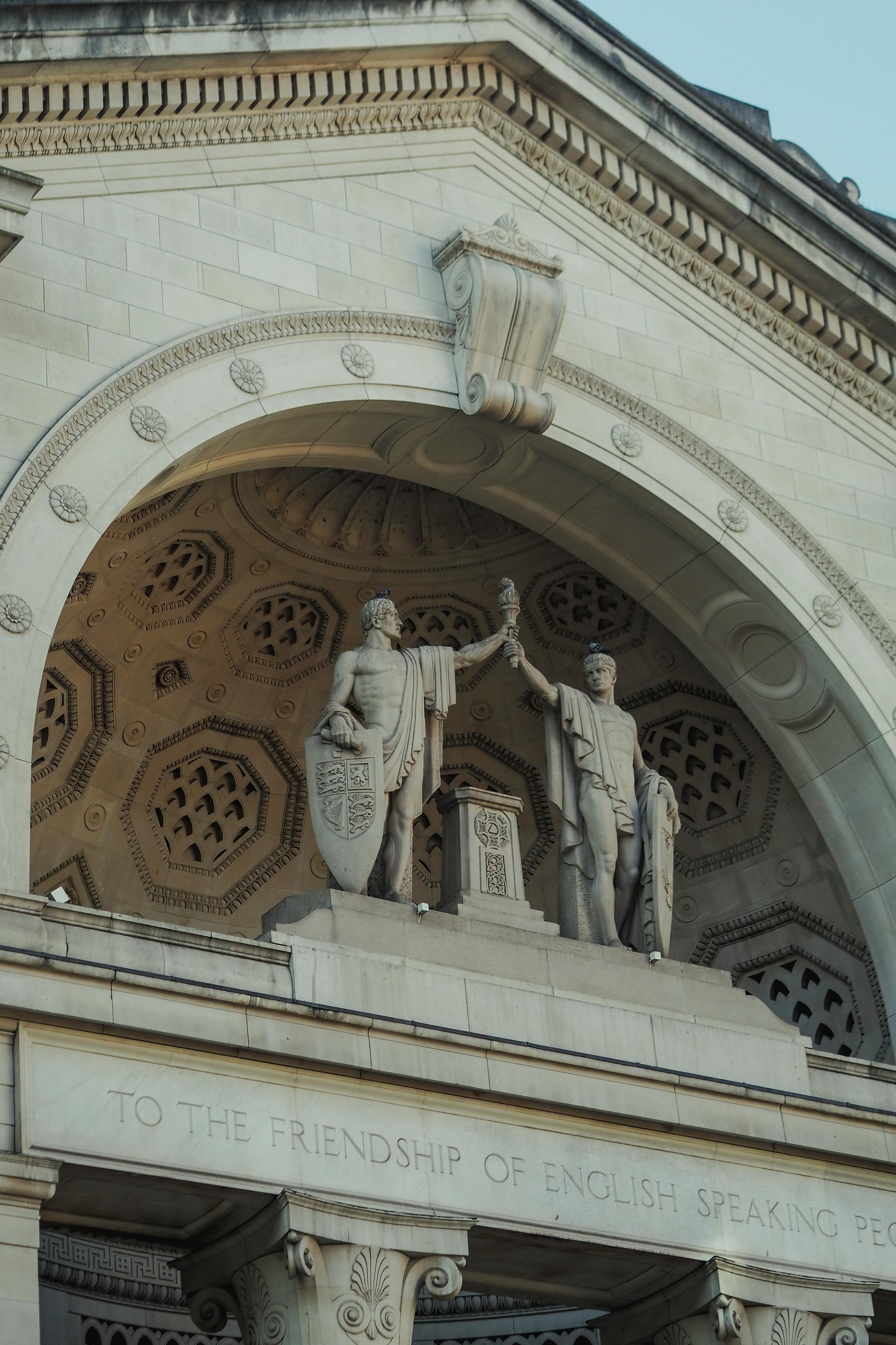 Statue on Building Wall · Free Stock Photo