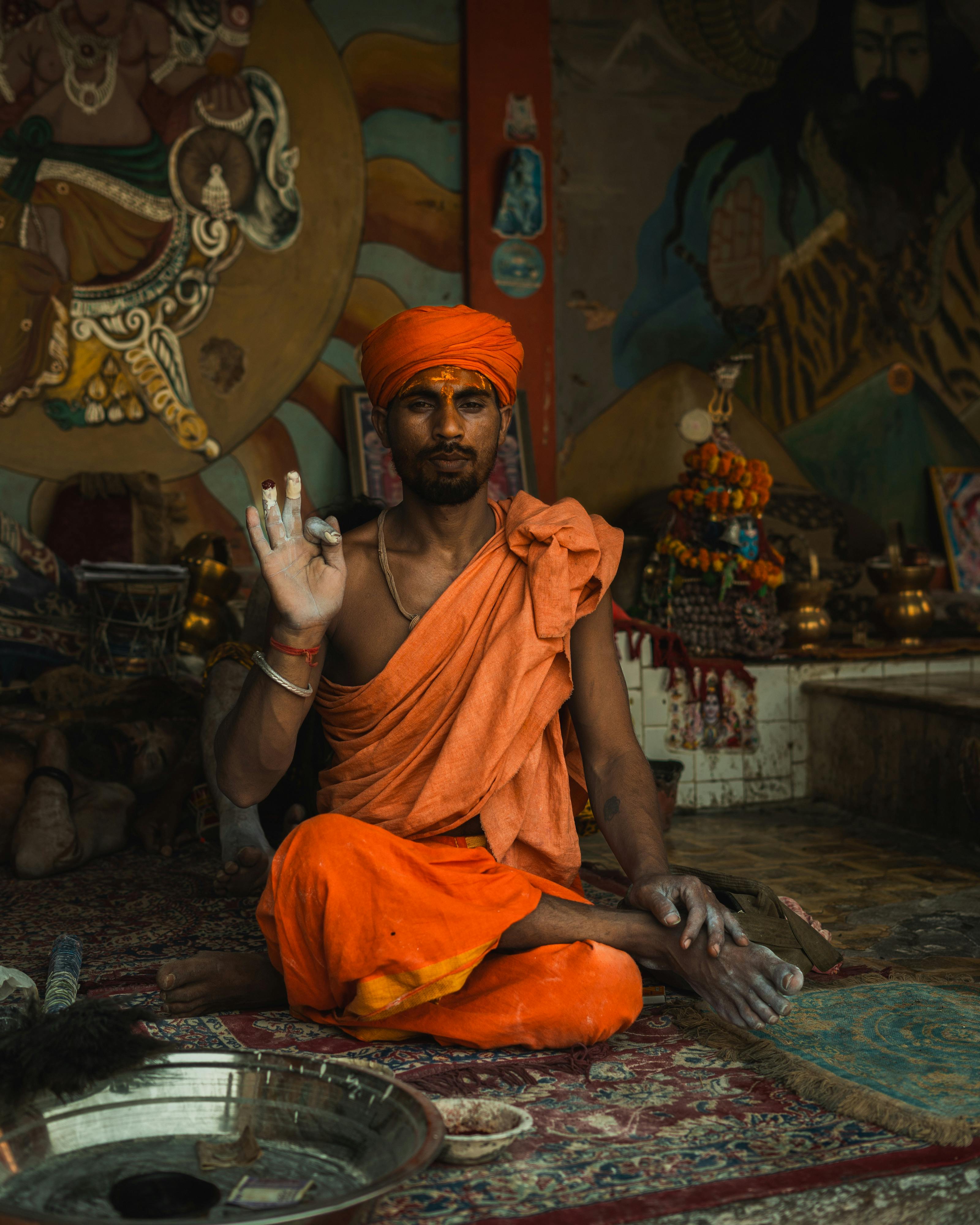 Buddhist Monk Sitting on Orange Robes and with Hand Raised · Free Stock ...