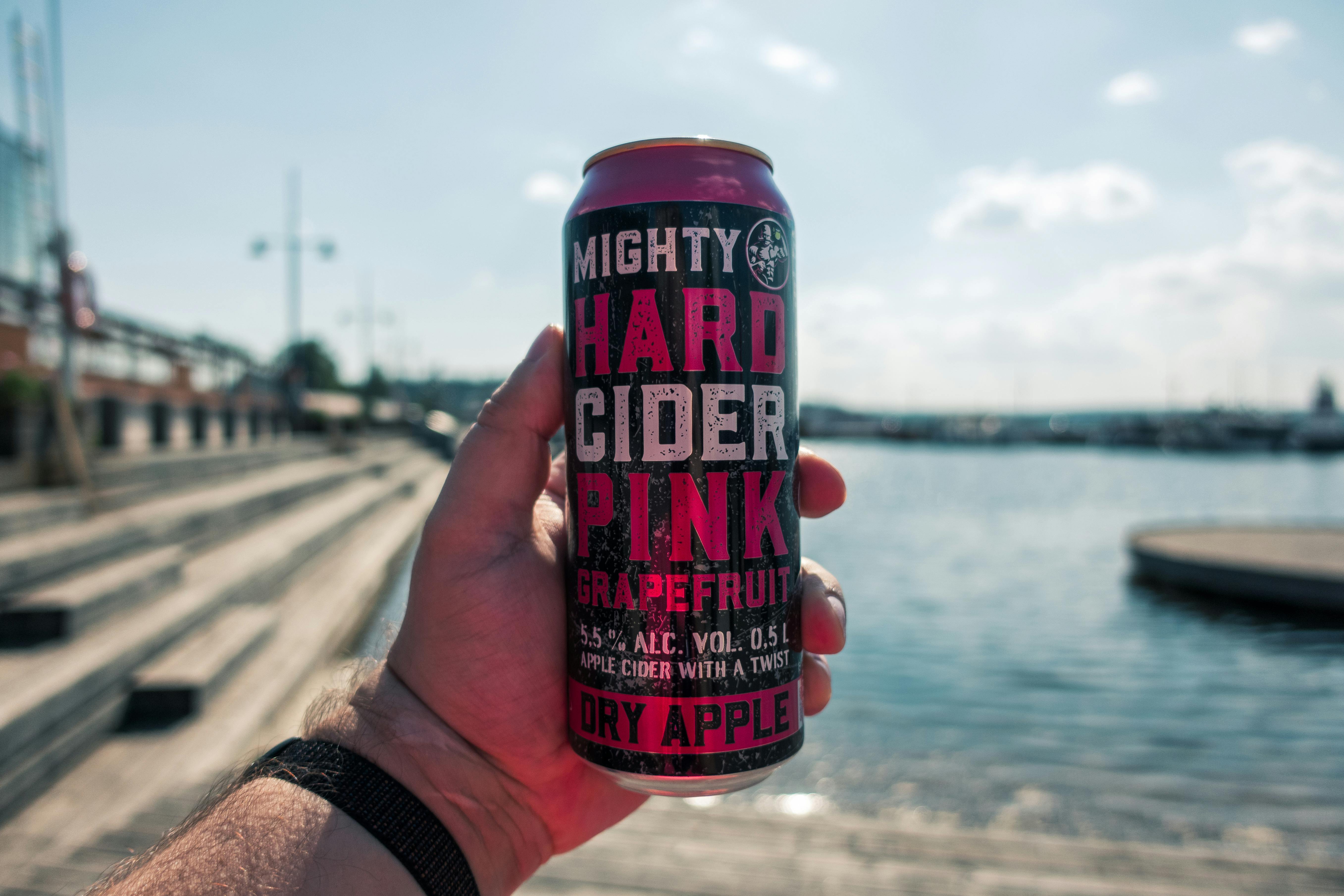 Man Hand Holding Can of Cider · Free Stock Photo
