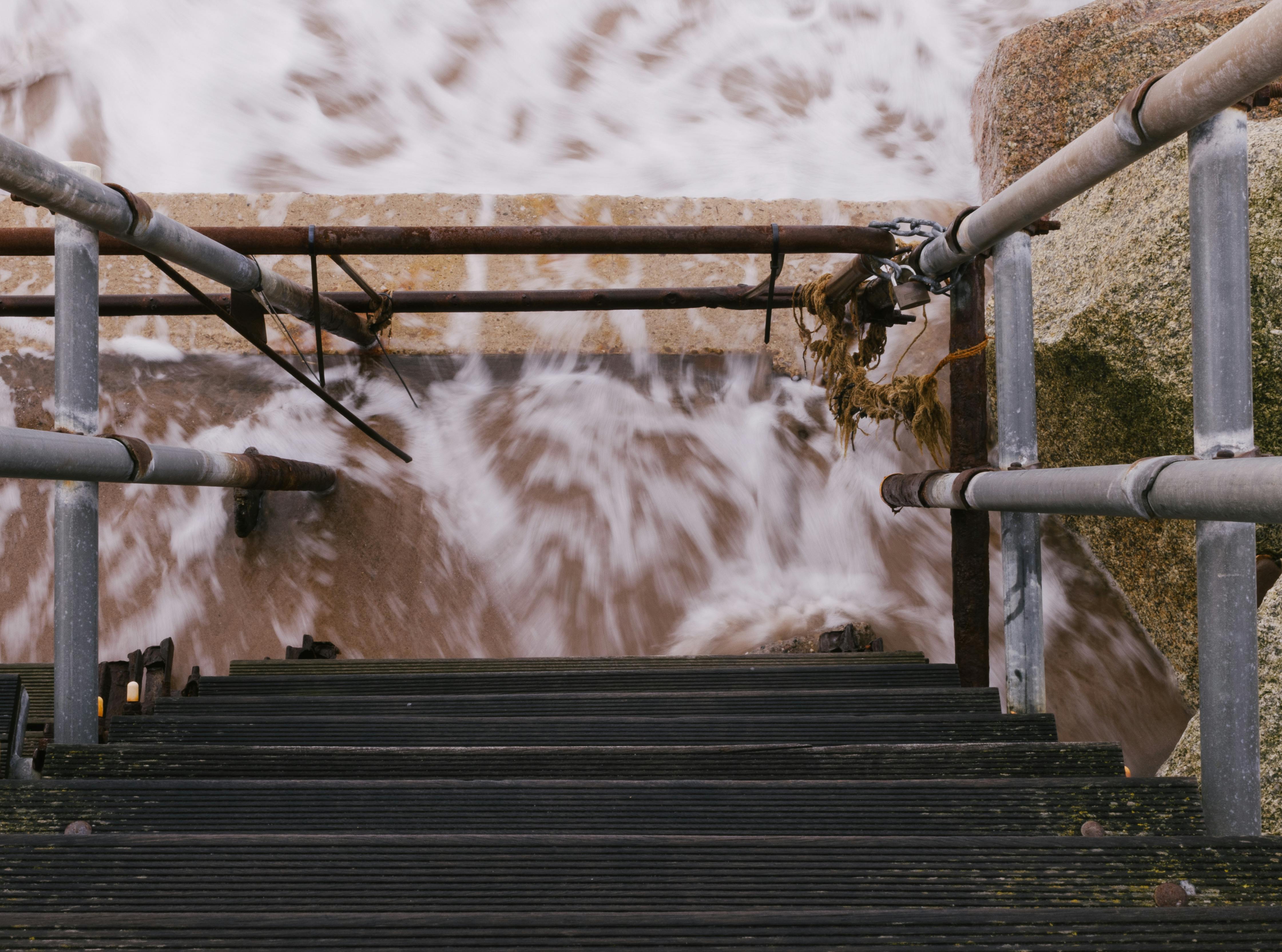 Wave under Railing Bars · Free Stock Photo