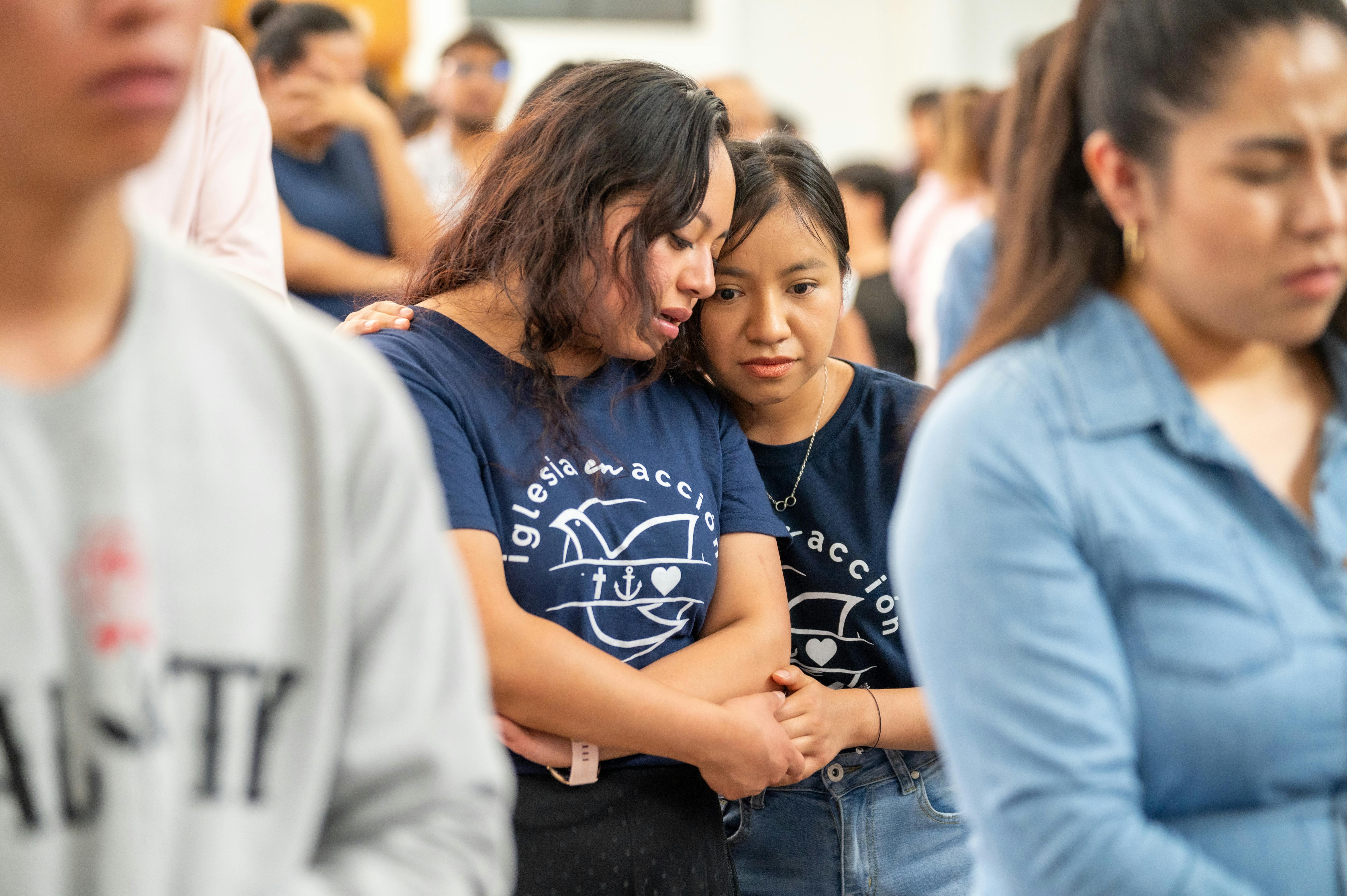 A group of people in a church praying together · Free Stock Photo