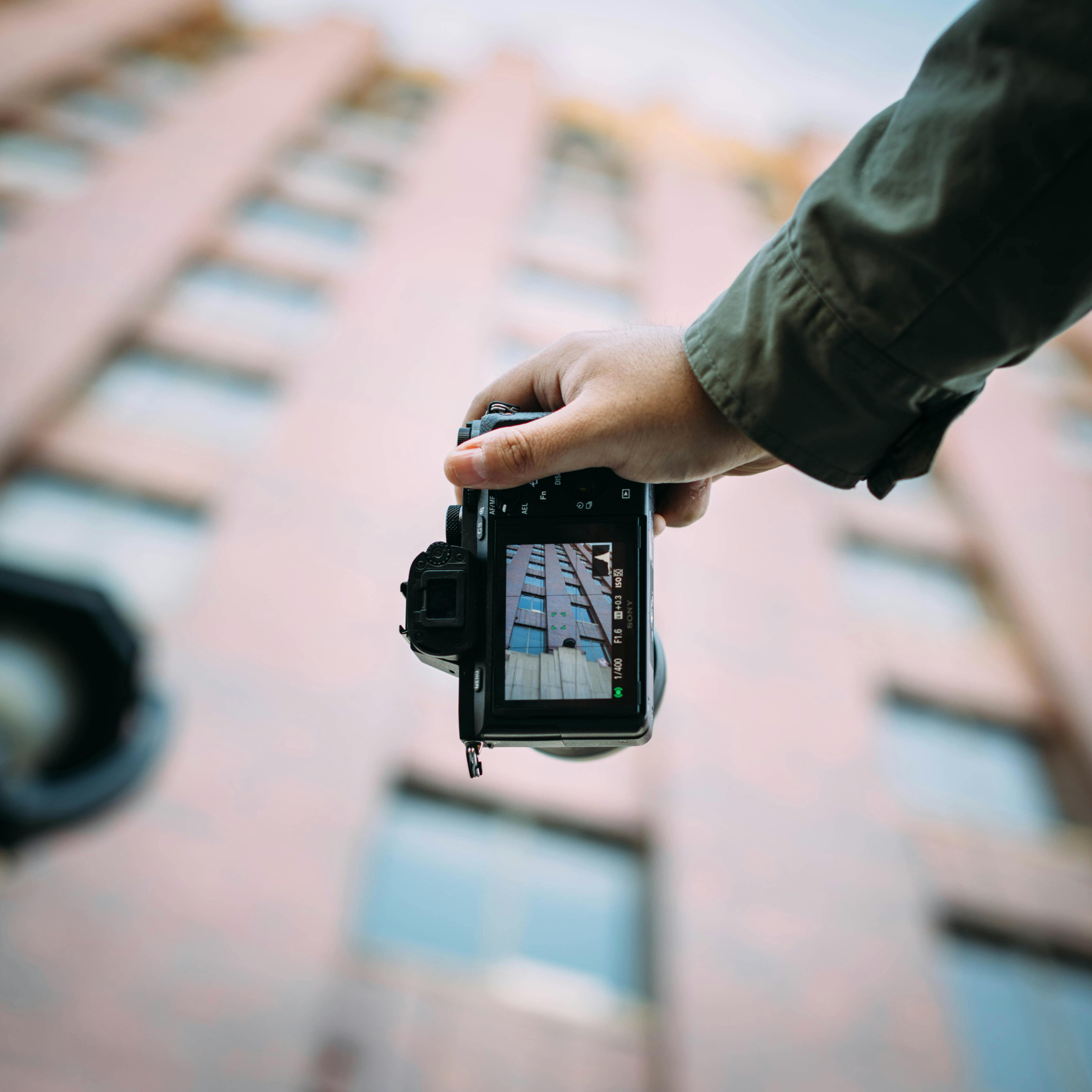 Shallow Focus Photography of Person Holding Black Dslr Camera · Free ...