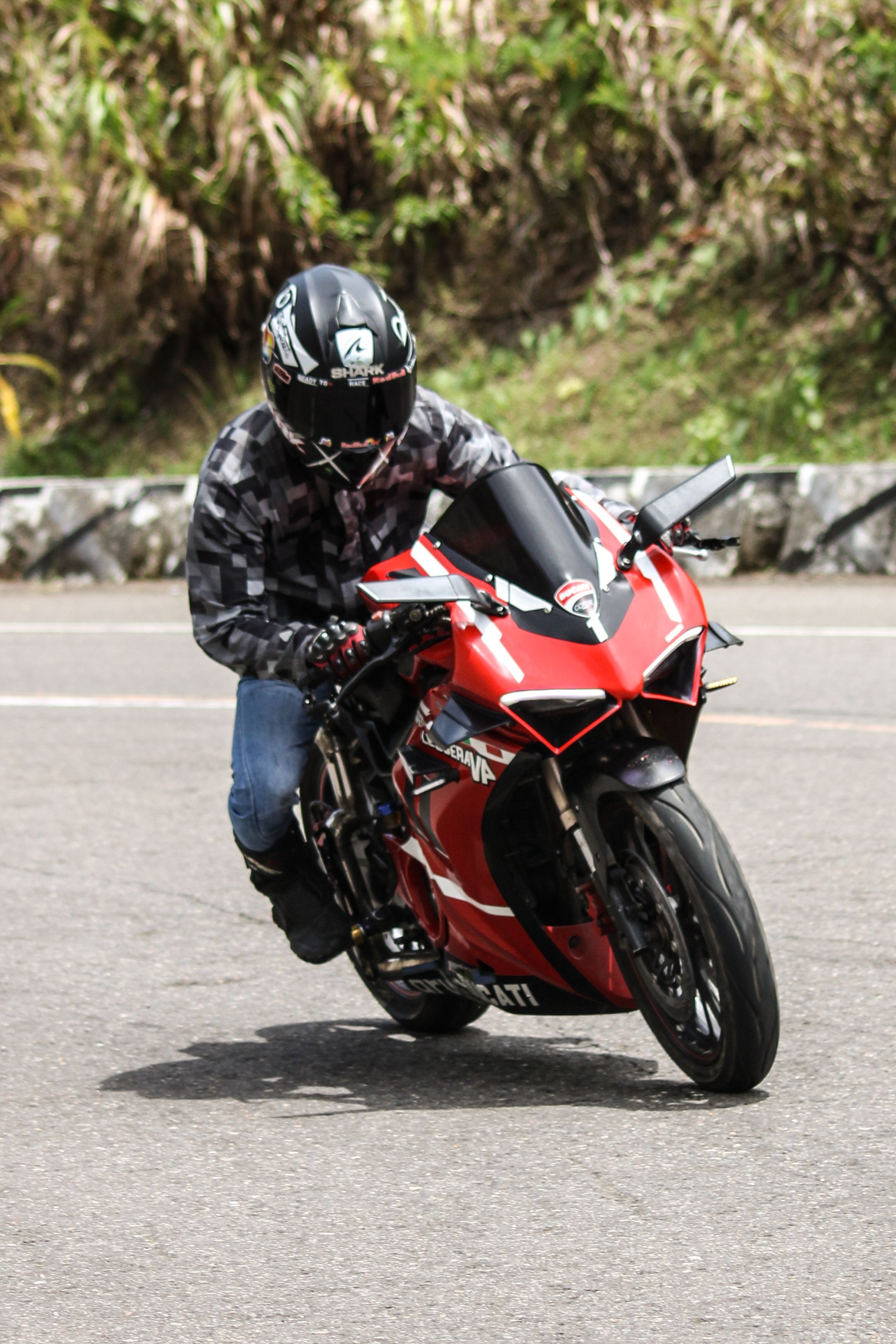 A person riding a motorcycle on a road · Free Stock Photo