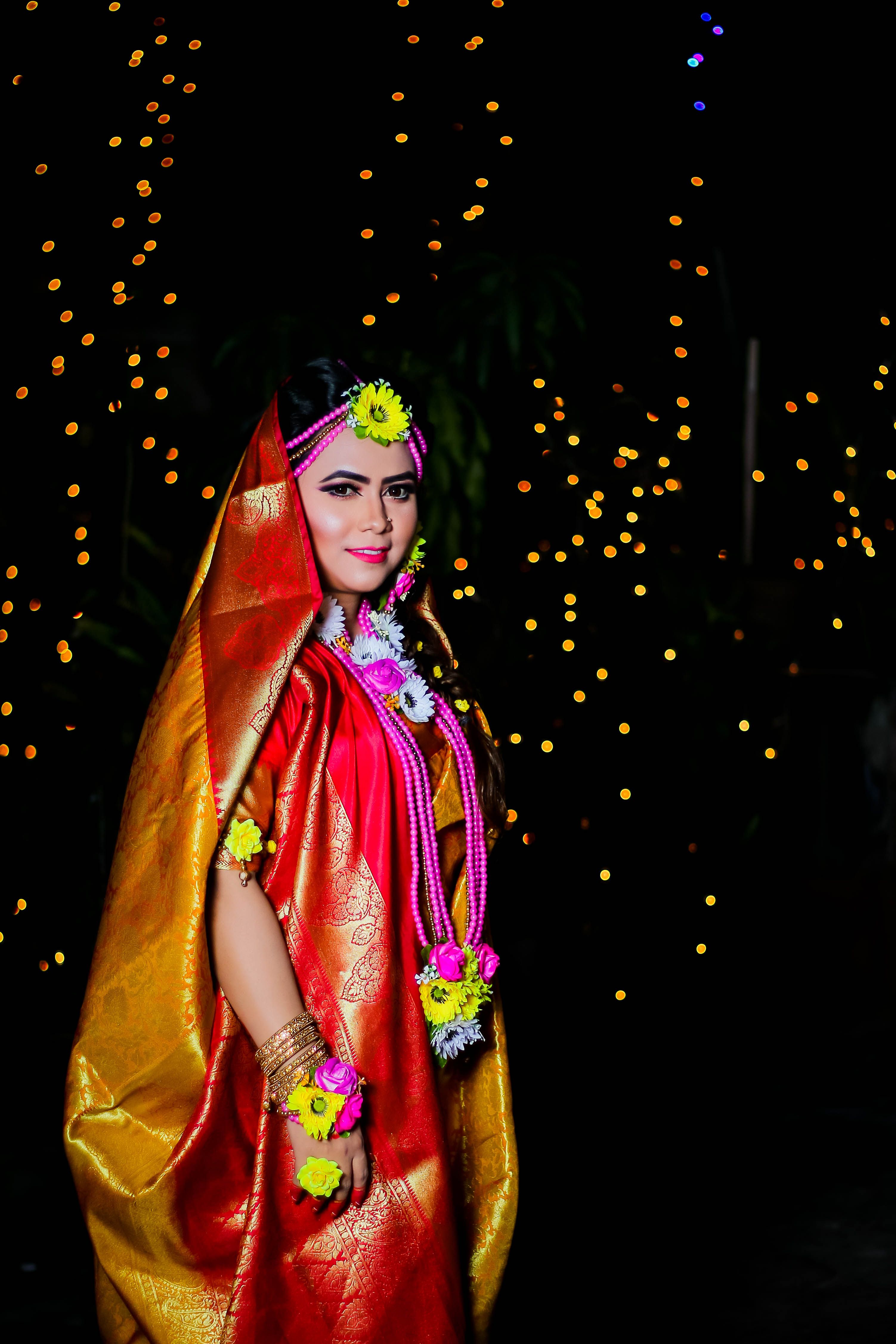 A woman in traditional garb posing for the camera · Free Stock Photo