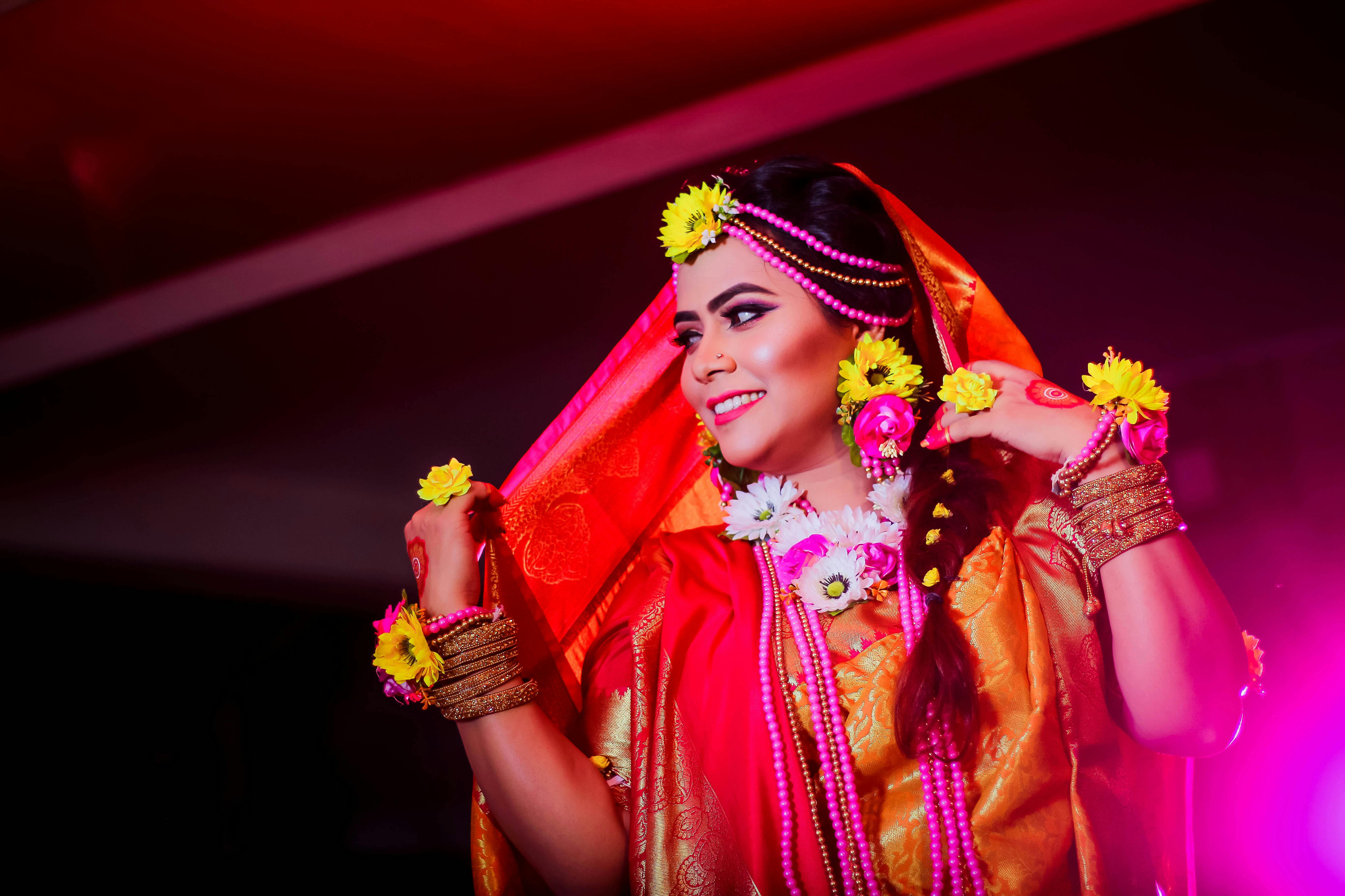 Smiling Woman in Traditional Clothing with Flowers · Free Stock Photo