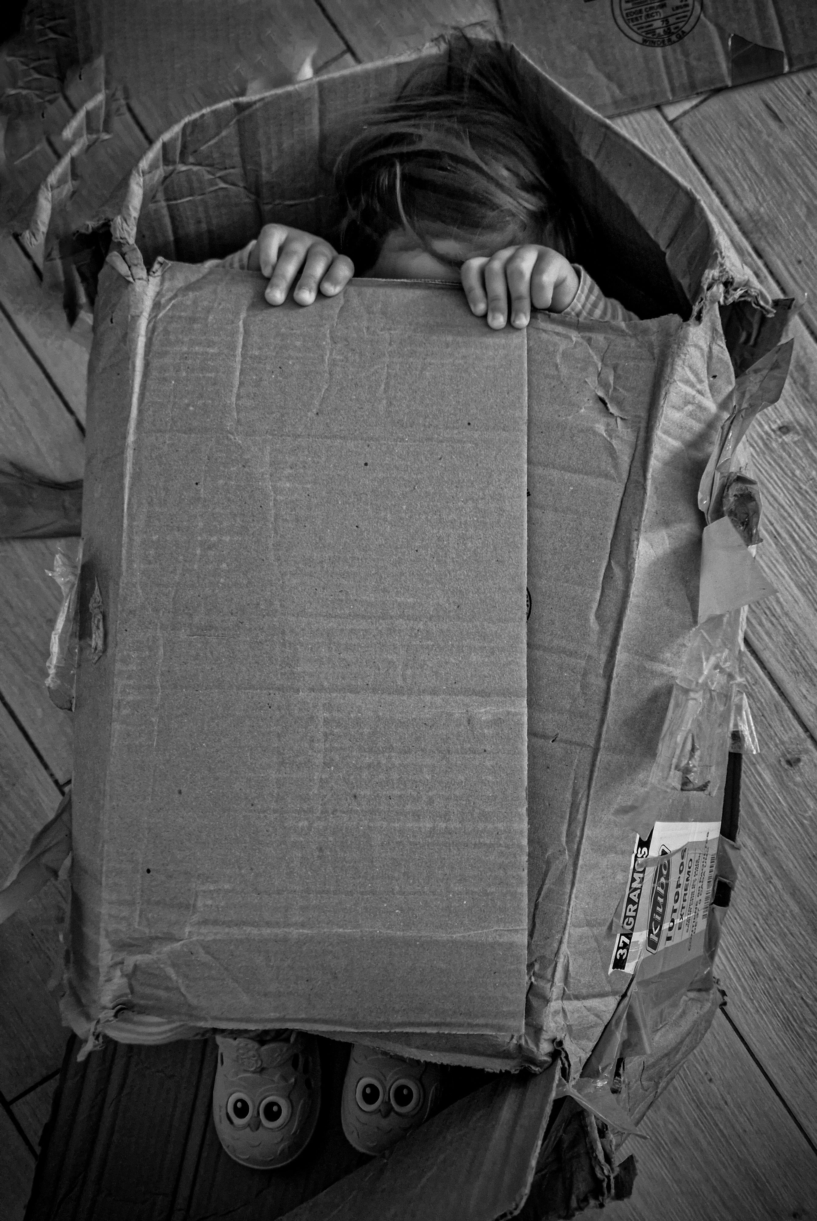 Anonymous black little kid hiding in wardrobe · Free Stock Photo
