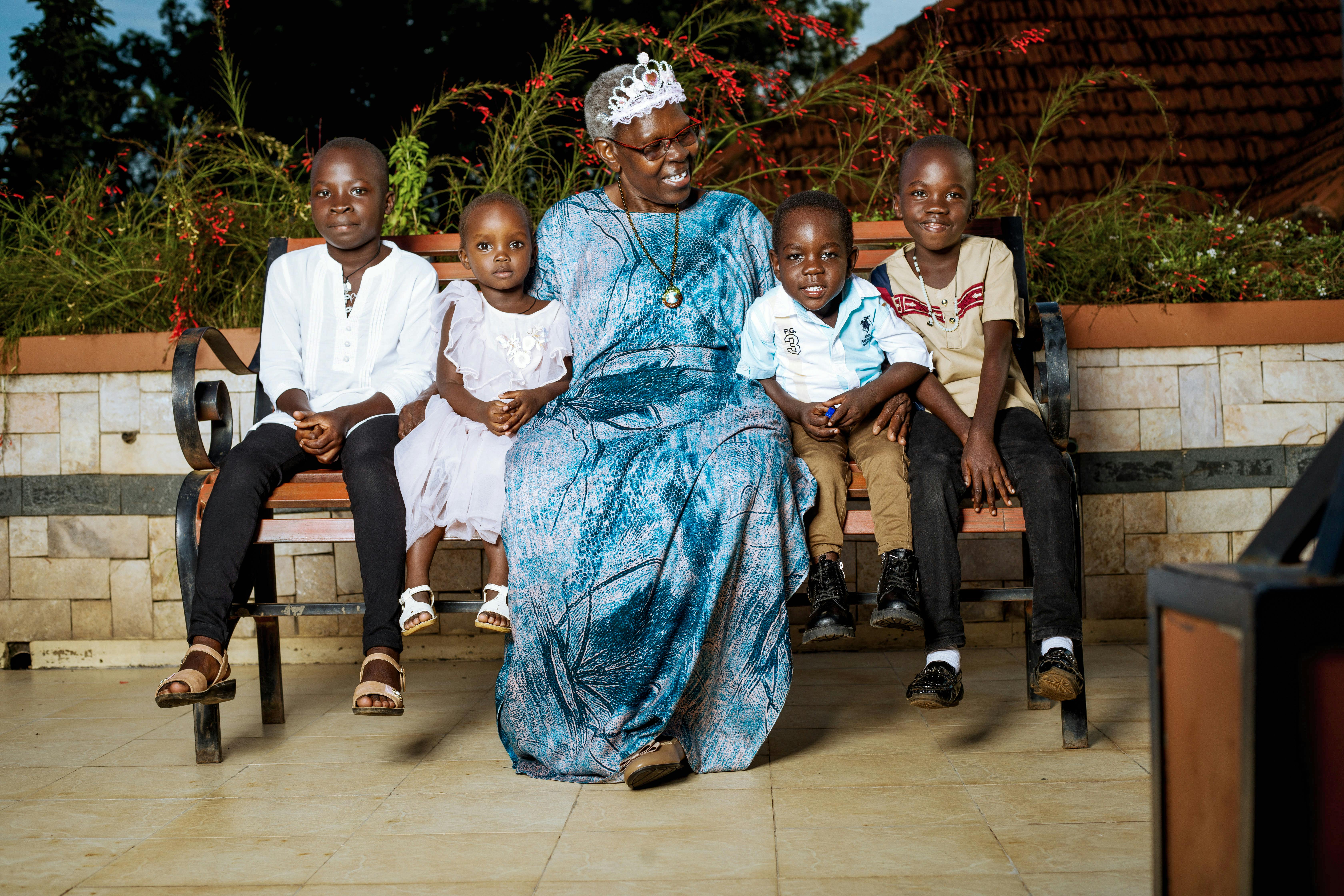 Grandmother in Traditional Dress Sitting with Grandsons and ...