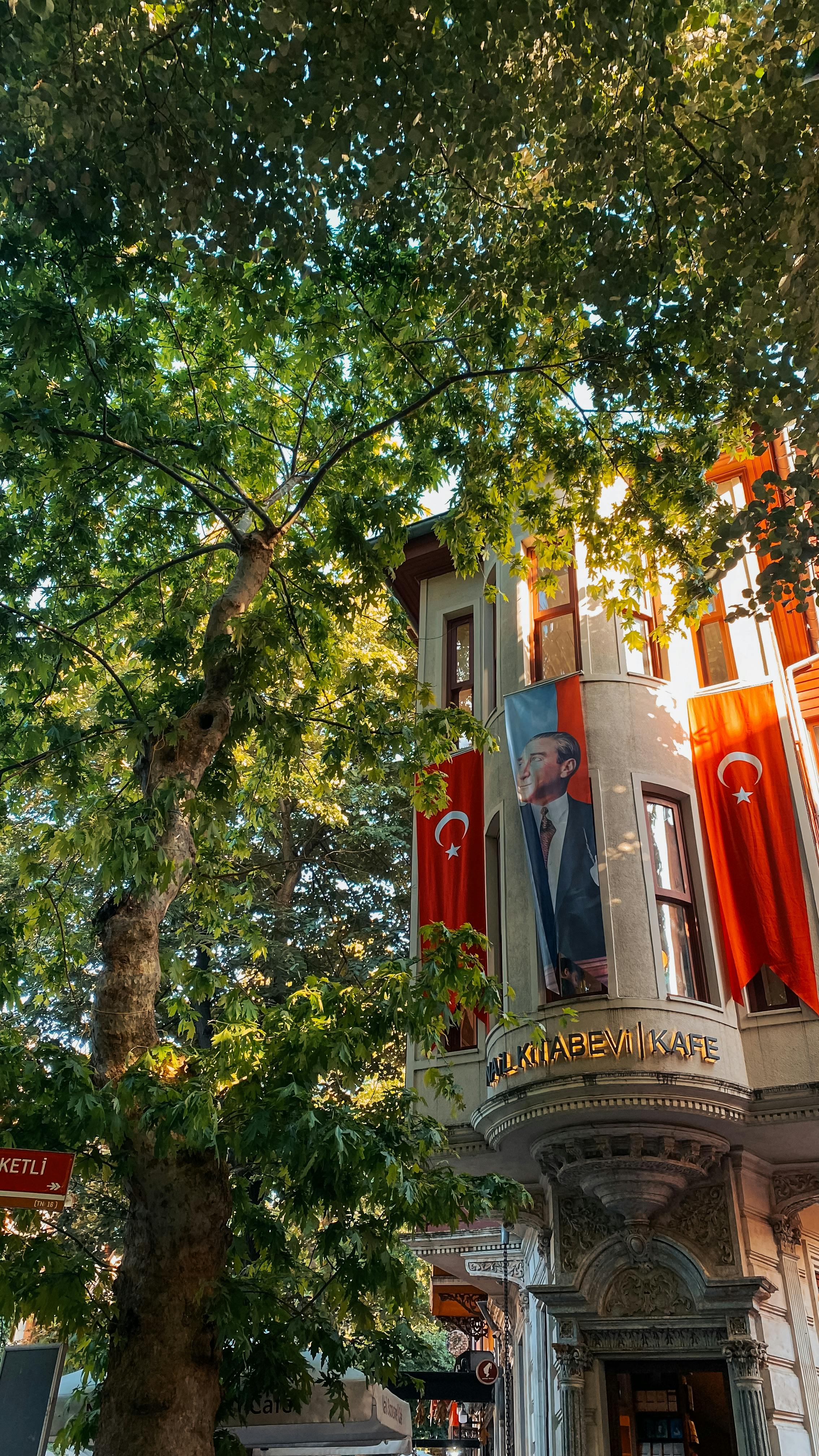 Flags on the Facade of a Bookstore and Cafe in Istanbul · Free Stock Photo