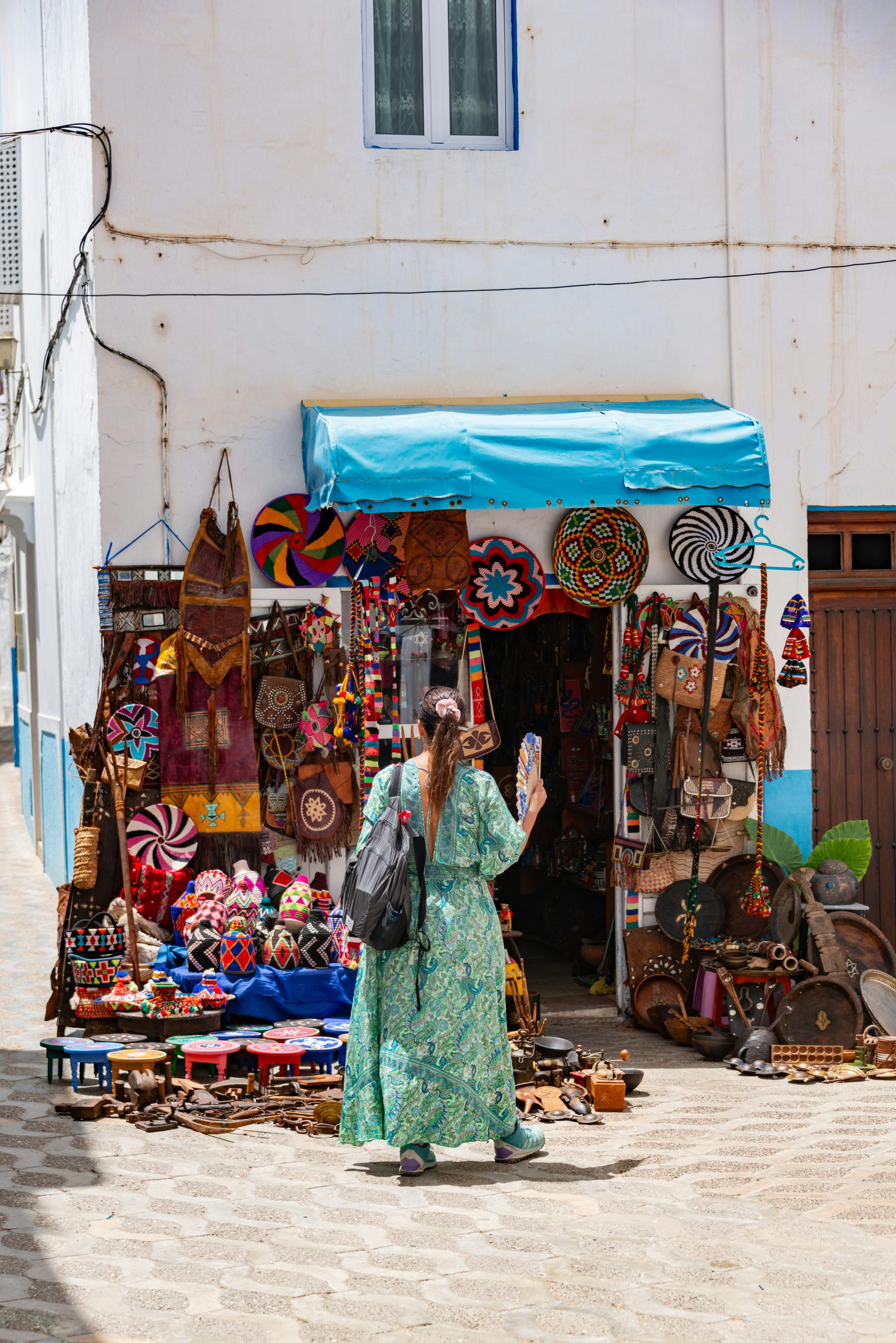 Back View of a Woman Standing in Front of a Shop · Free Stock Photo