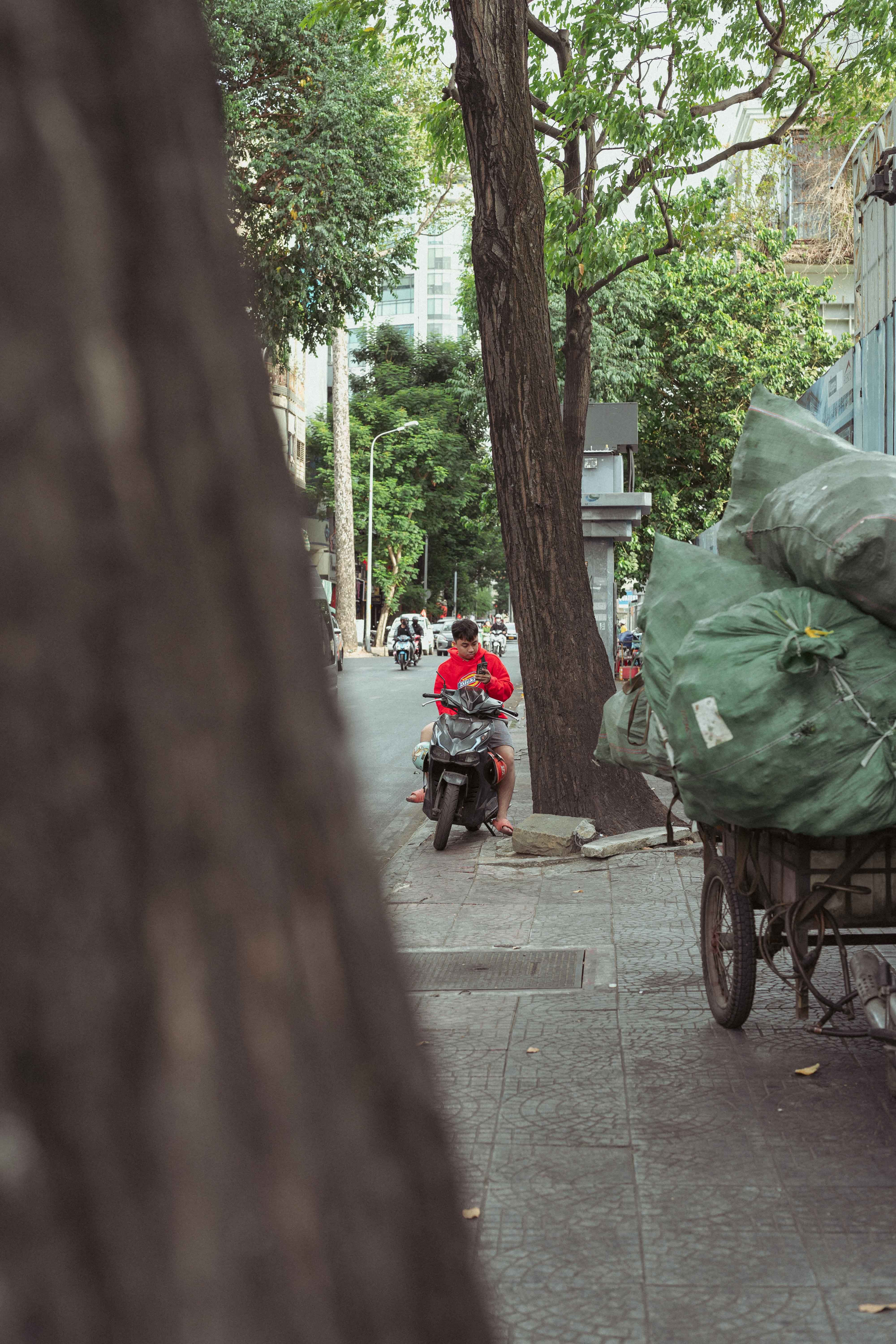 Urban Street Scene with Motorbike Transporting Goods · Free Stock Photo