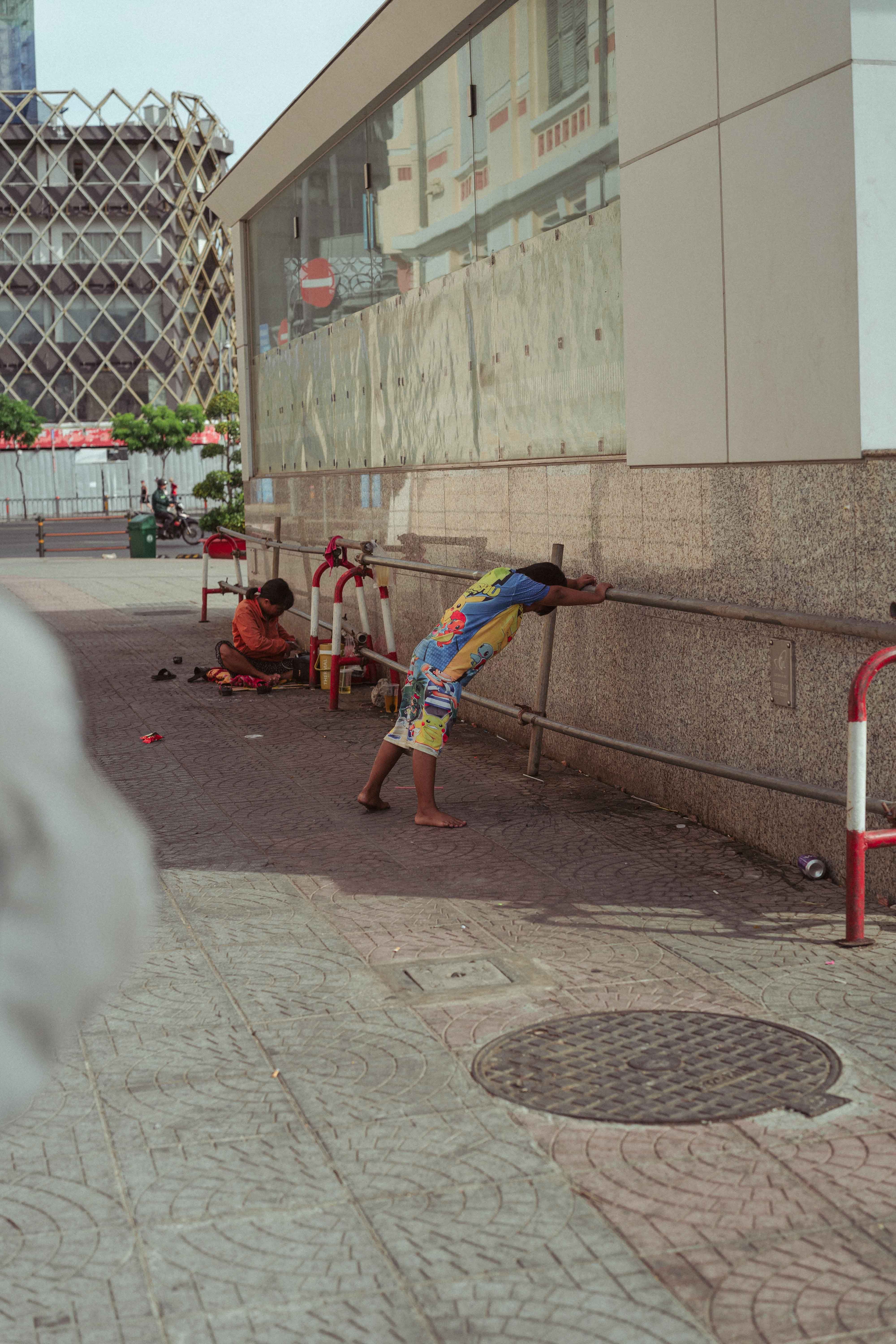 Children Playing Barefoot with Railings near Building · Free Stock Photo