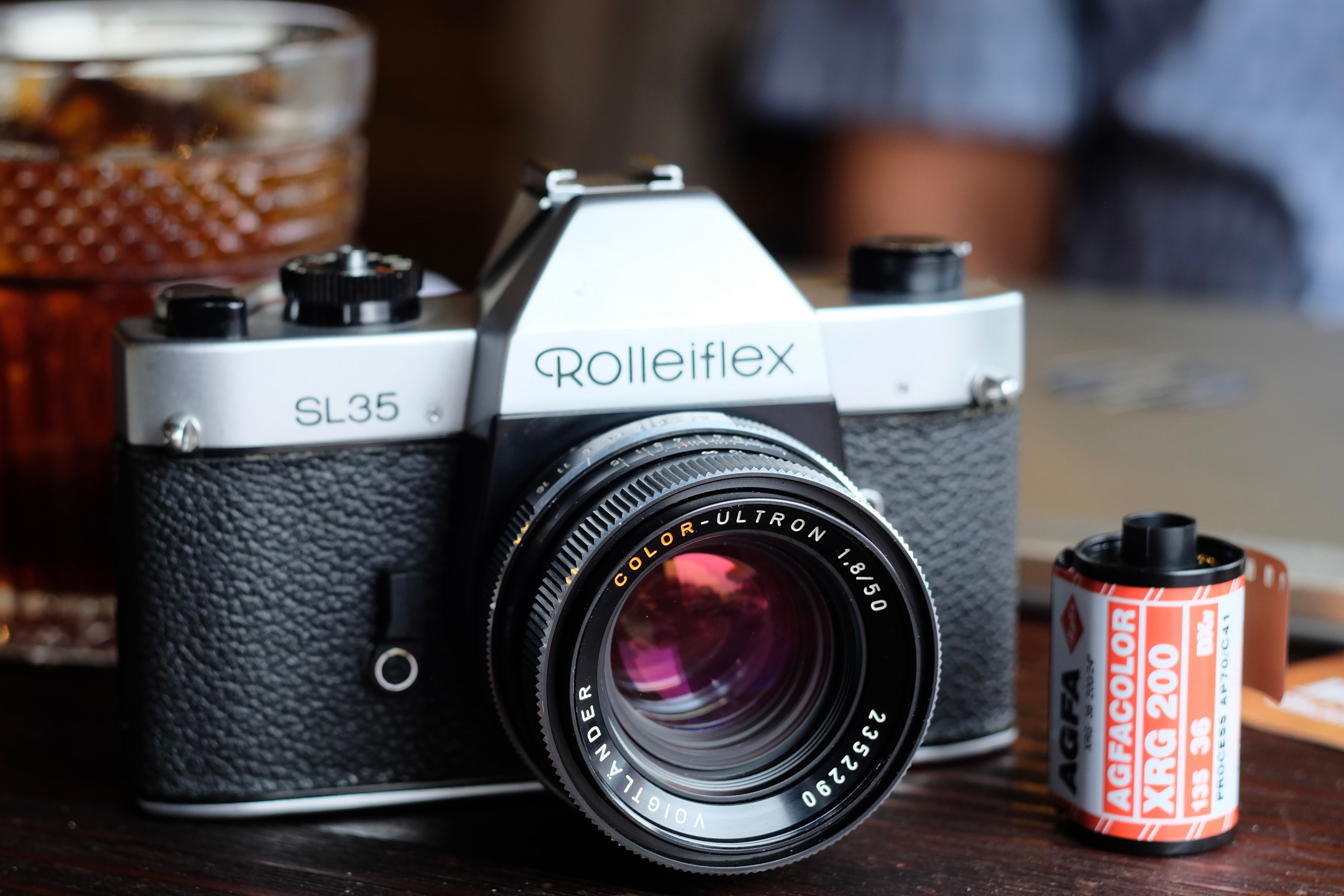 A camera with a film and a can of soda · Free Stock Photo