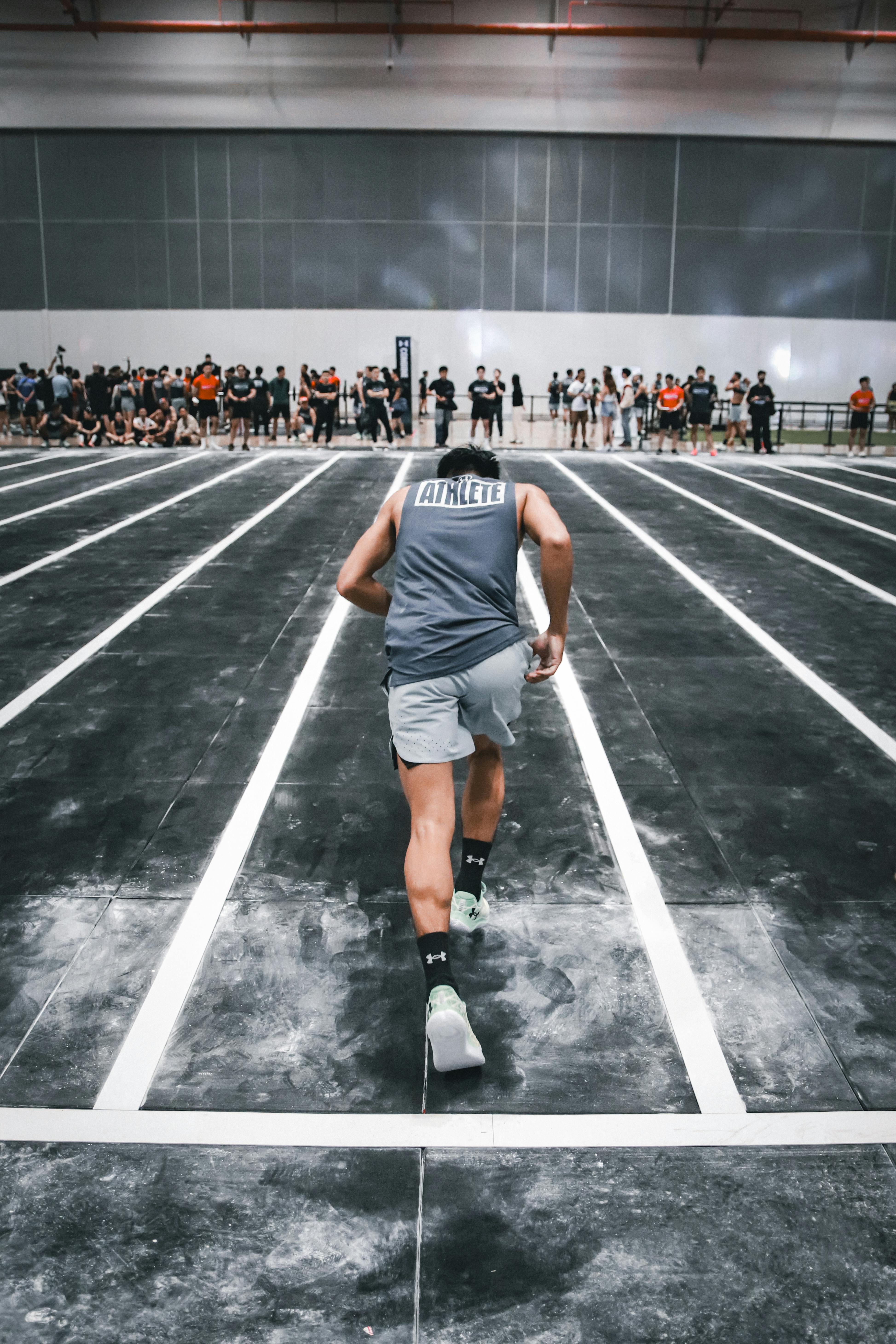 Man in White T-shirt and Black Pants In A Running Position · Free Stock ...