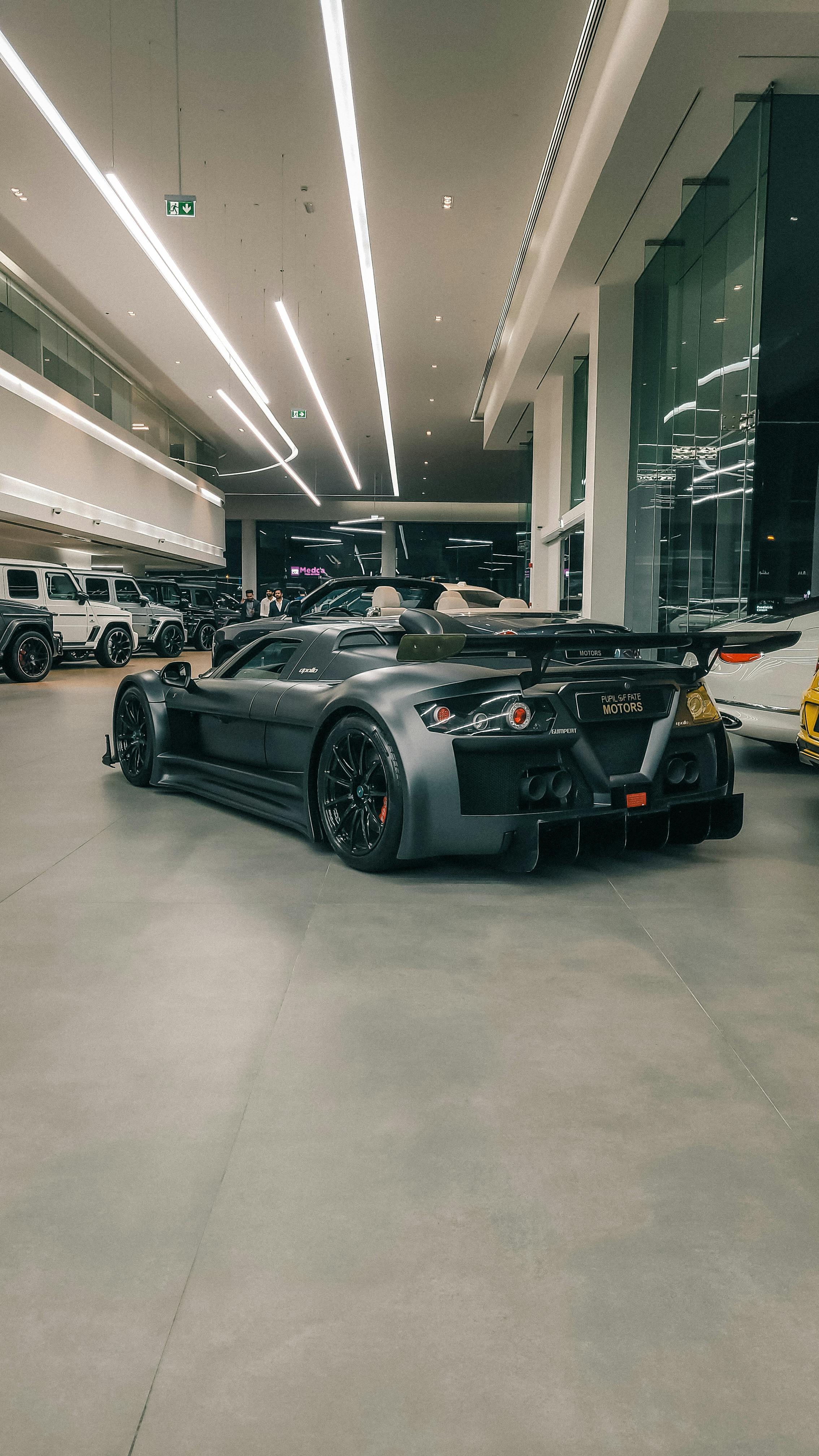 Grey Gumpert Apollo at the Car Dealership Showroom · Free Stock Photo