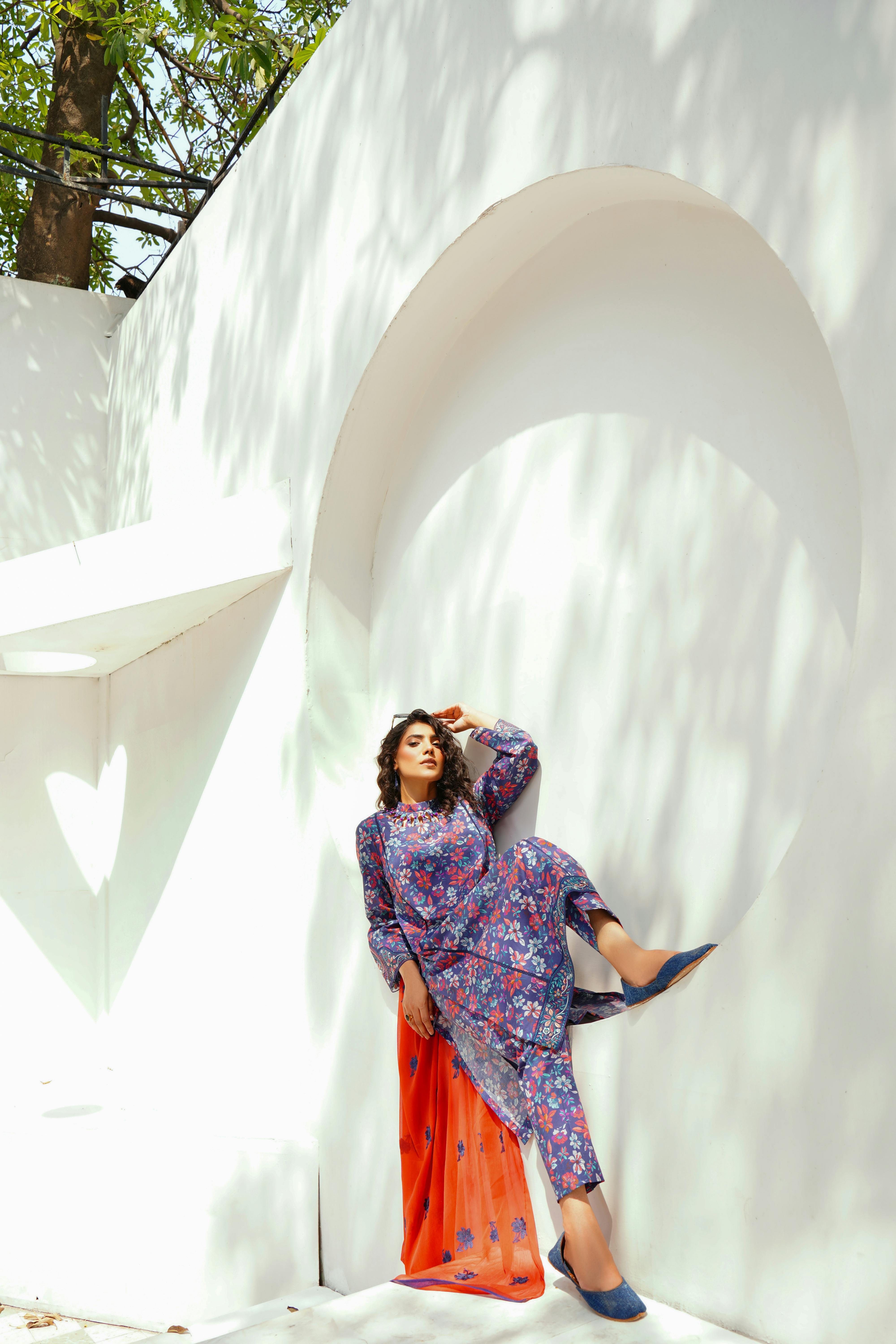 A Woman Posing in Traditional Patterned Clothing · Free Stock Photo
