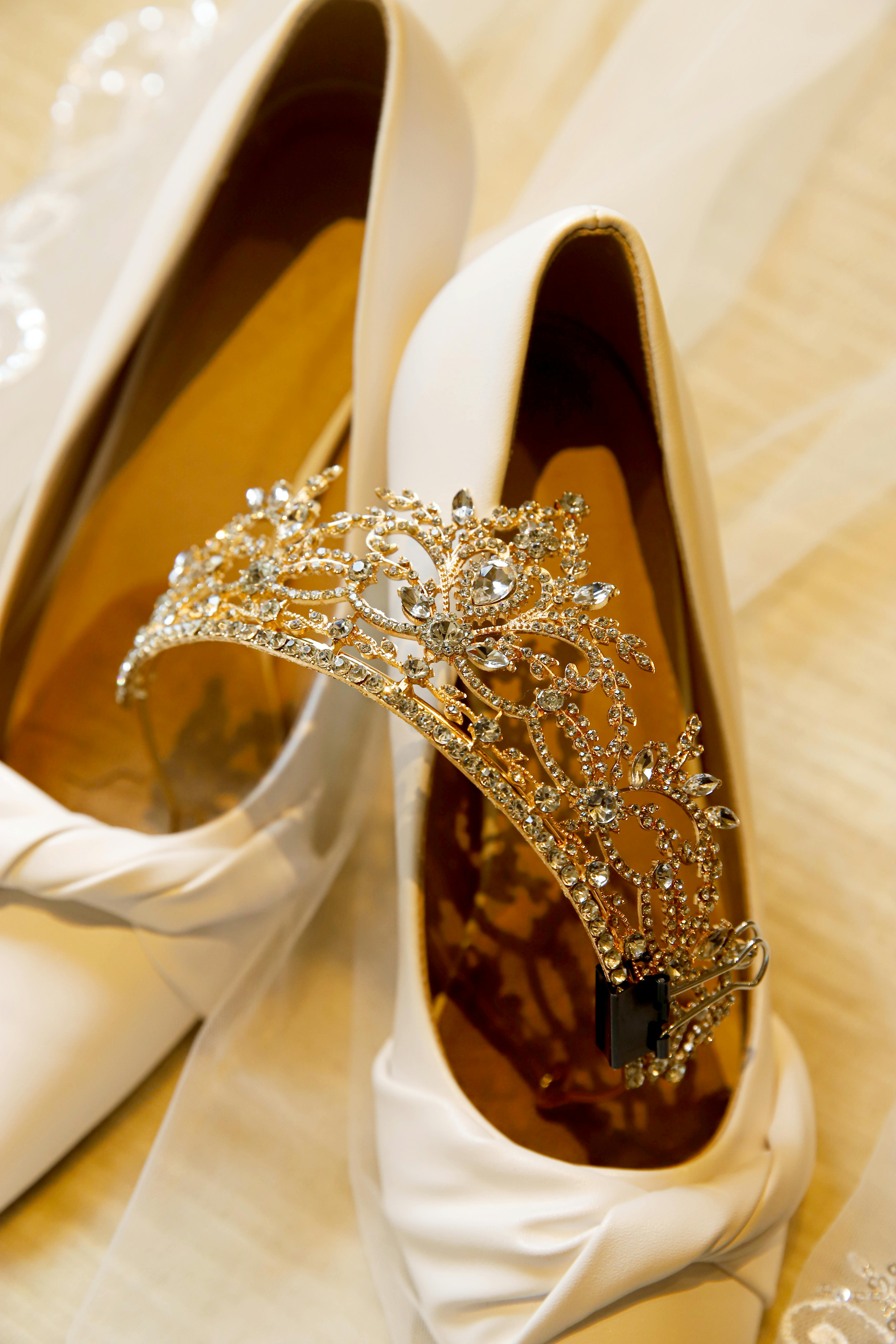 Close-up of a Tiara Lying on the Bridal Heels · Free Stock Photo