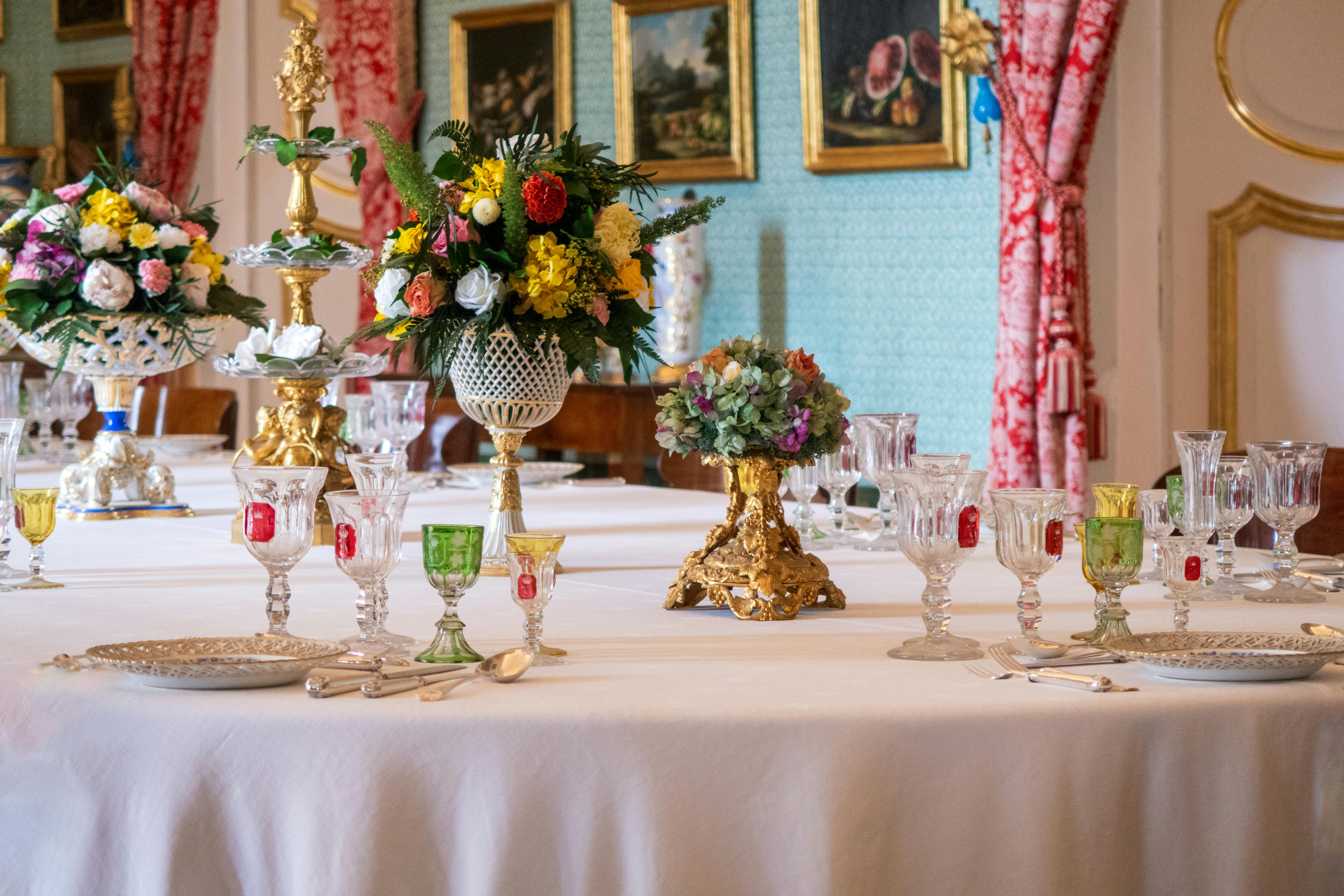 A fancy table with a lot of flowers and glasses · Free Stock Photo
