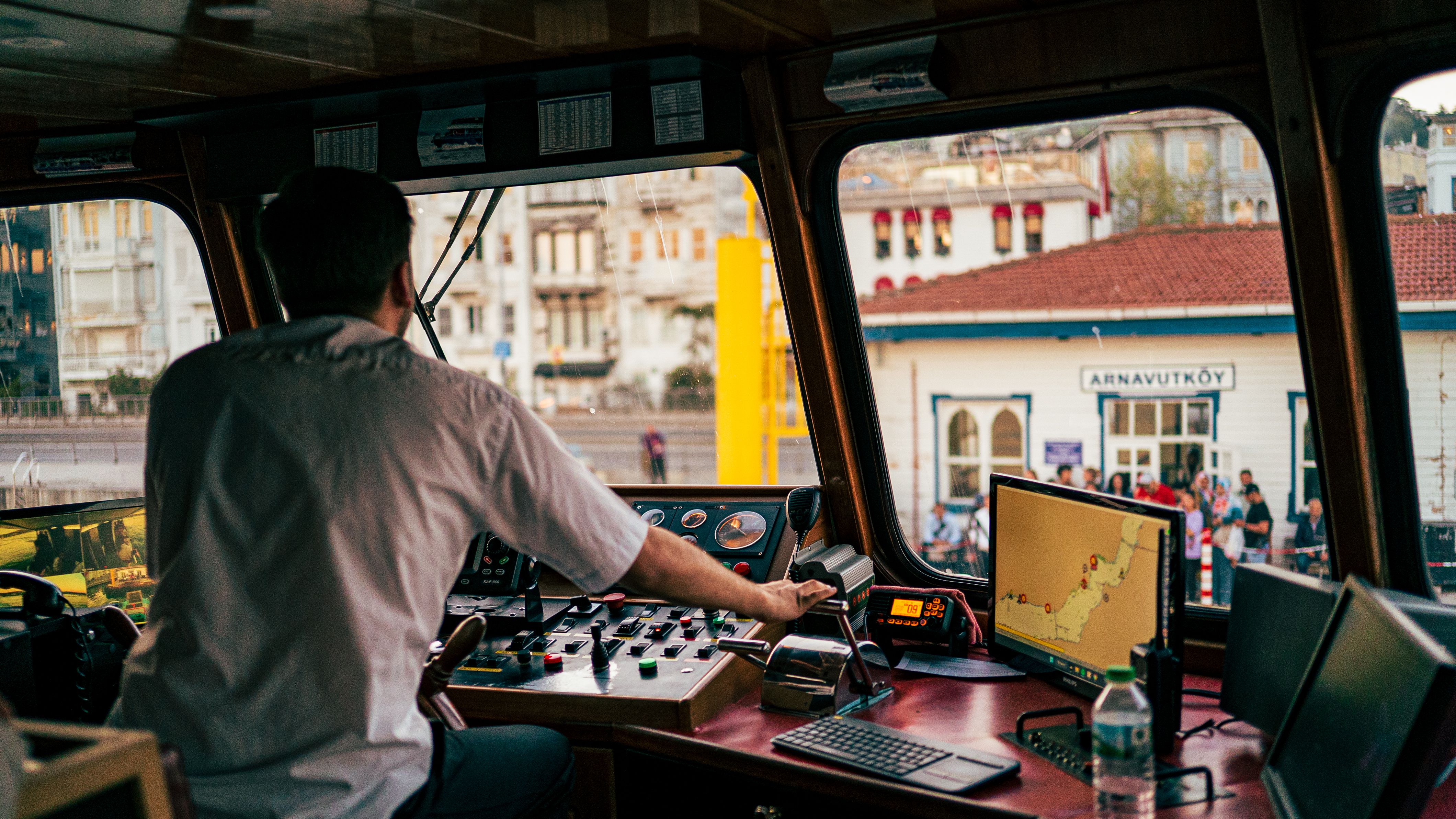 Back View of the Ferry Captain Sitting in the Wheelhouse · Free Stock Photo