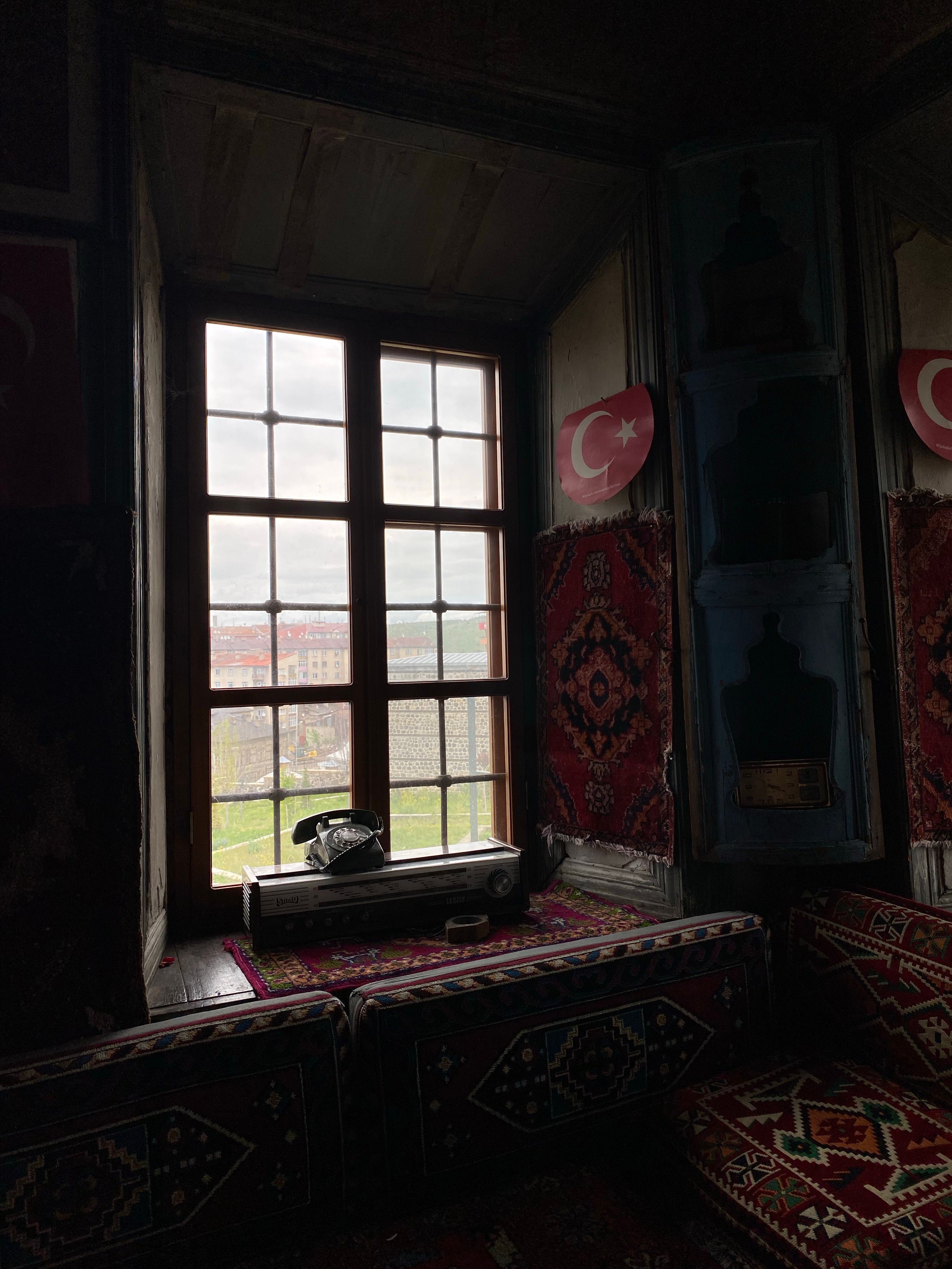 View of a Window in a Building with a Turkish Flag and Rugs on the ...