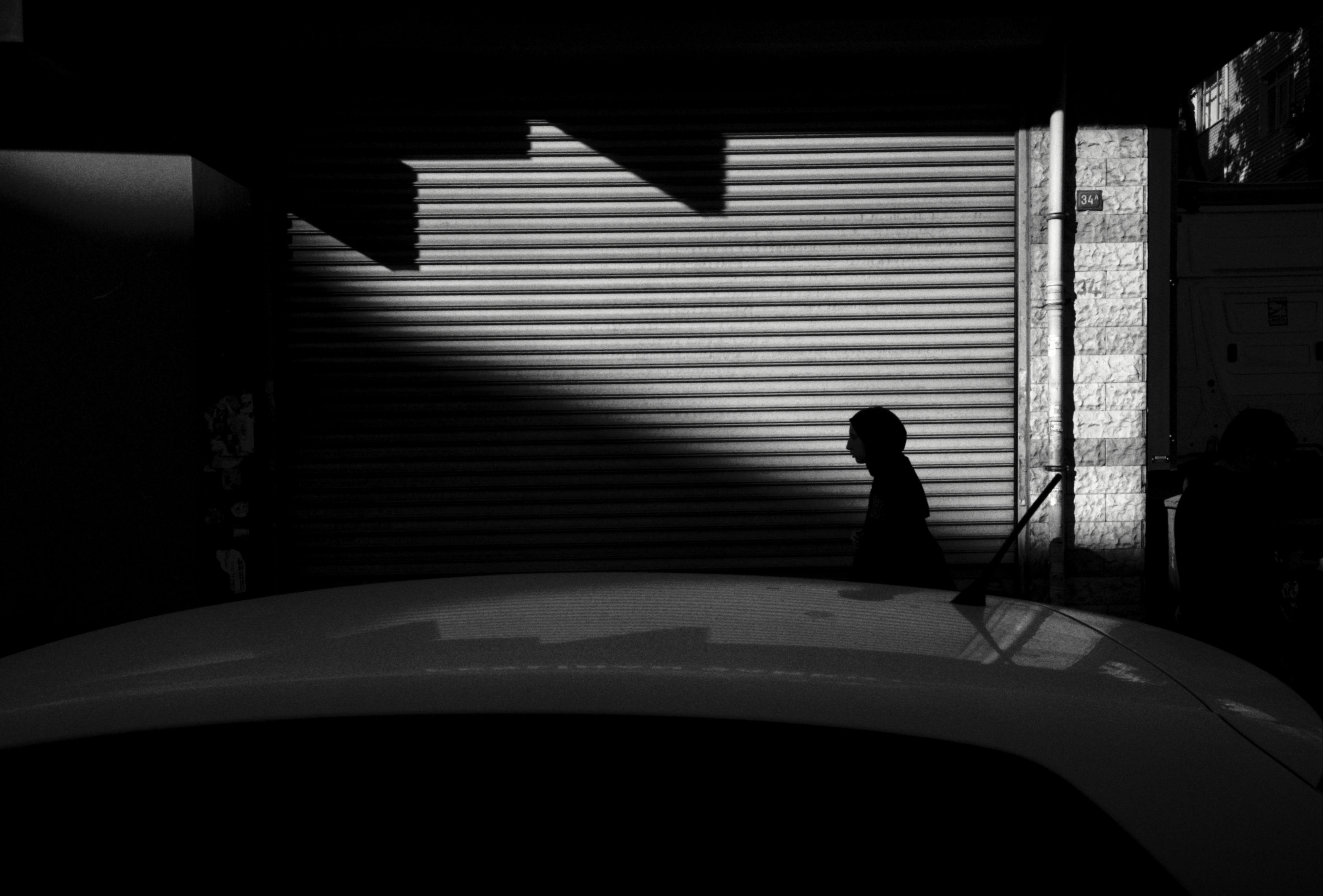 Person Passing from Sunlit into Shadow · Free Stock Photo