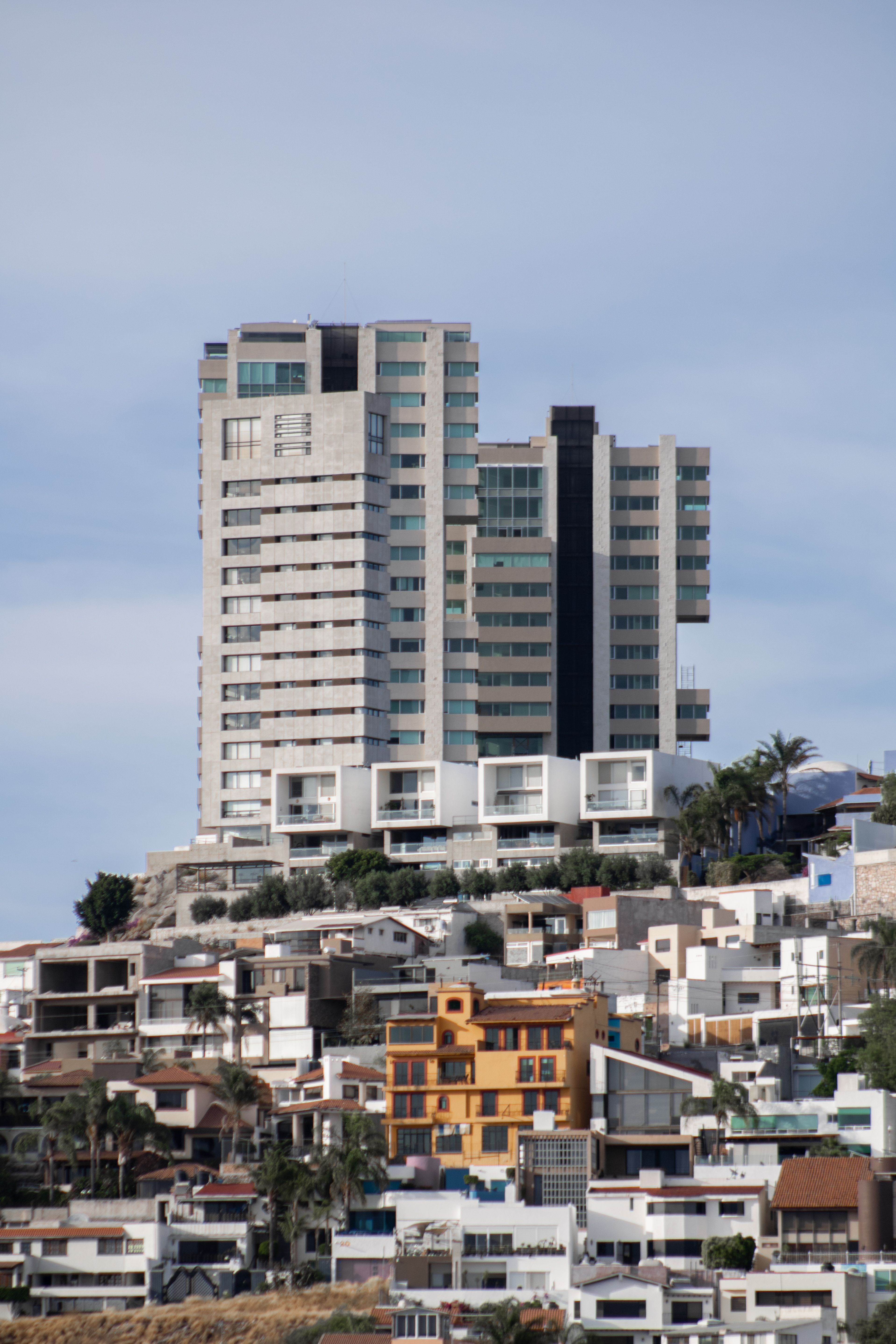 A large building on top of a hill with many buildings · Free Stock Photo