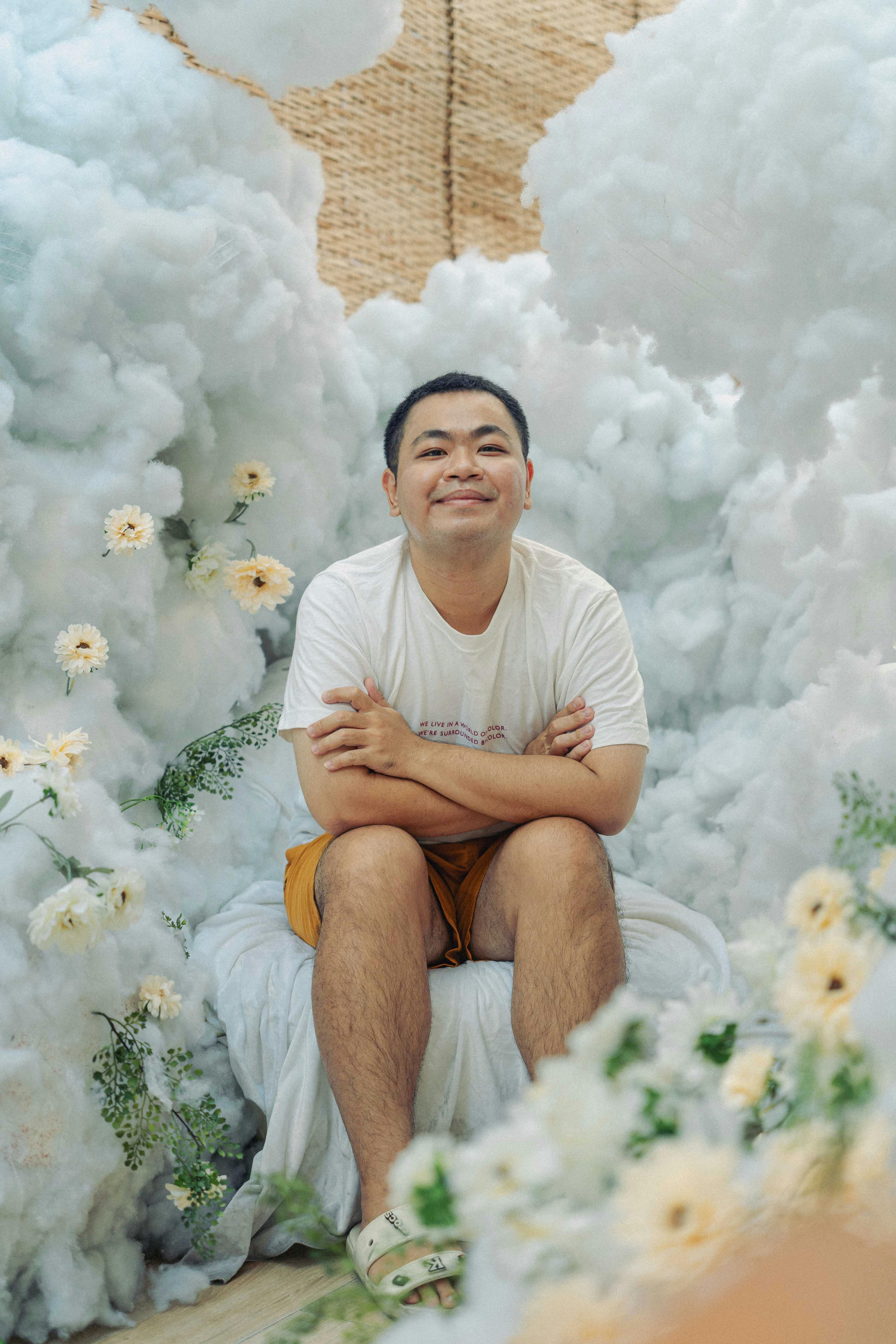 Photo of a Man Sitting in a Fluffy Decoration · Free Stock Photo
