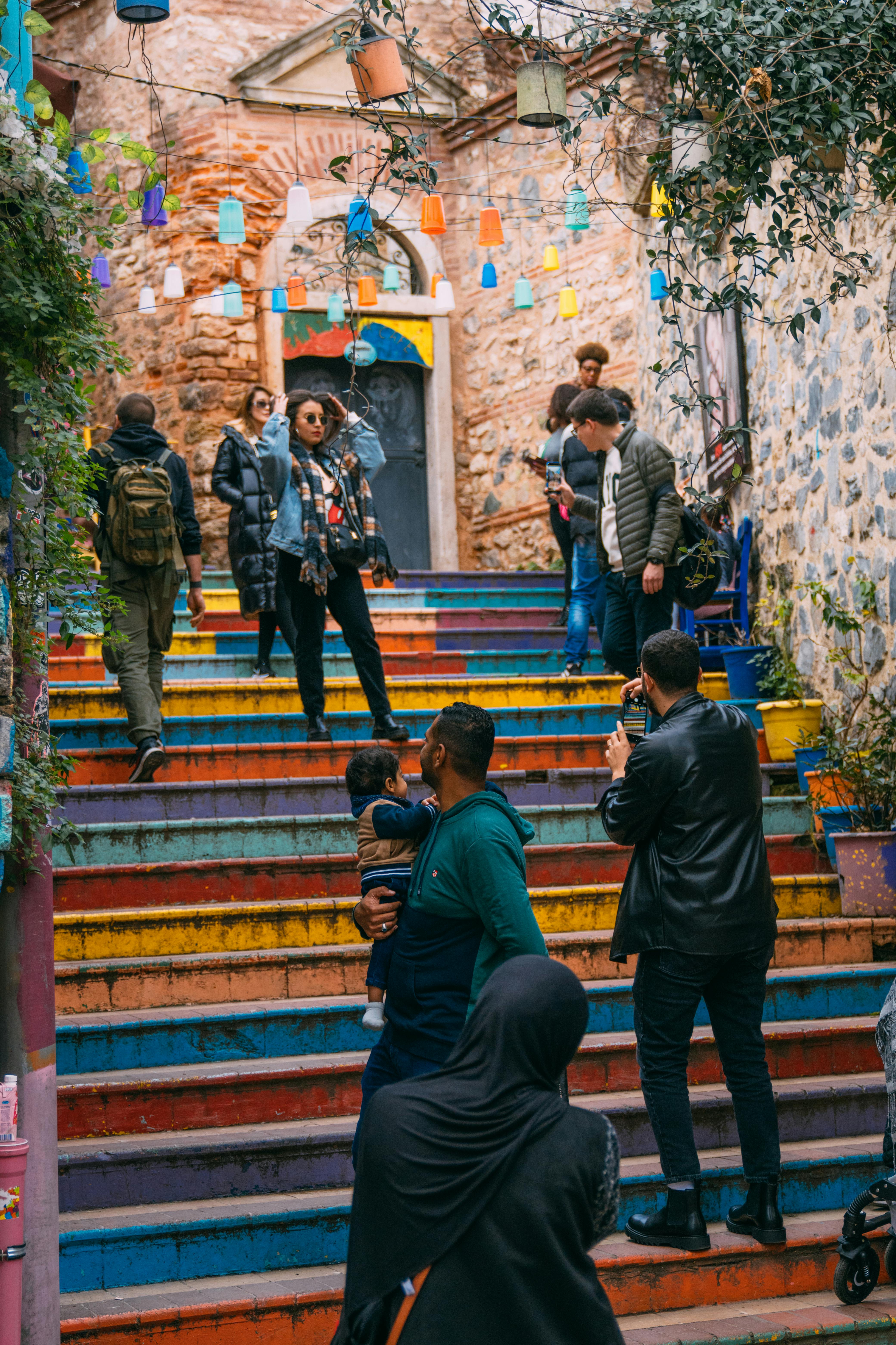People walking up stairs with colorful steps · Free Stock Photo