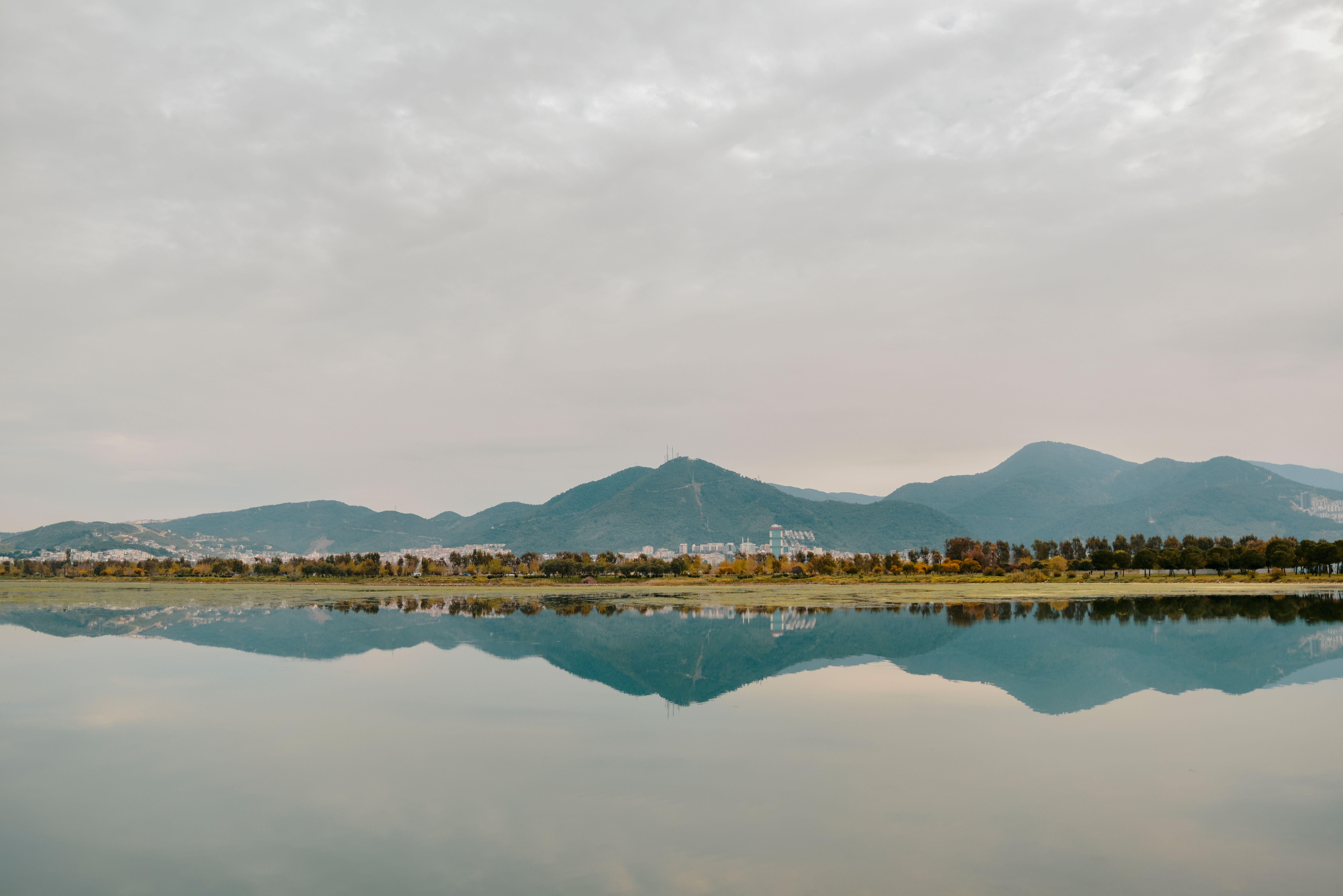 Mountain on Horizon and Its Reflection on Lake · Free Stock Photo