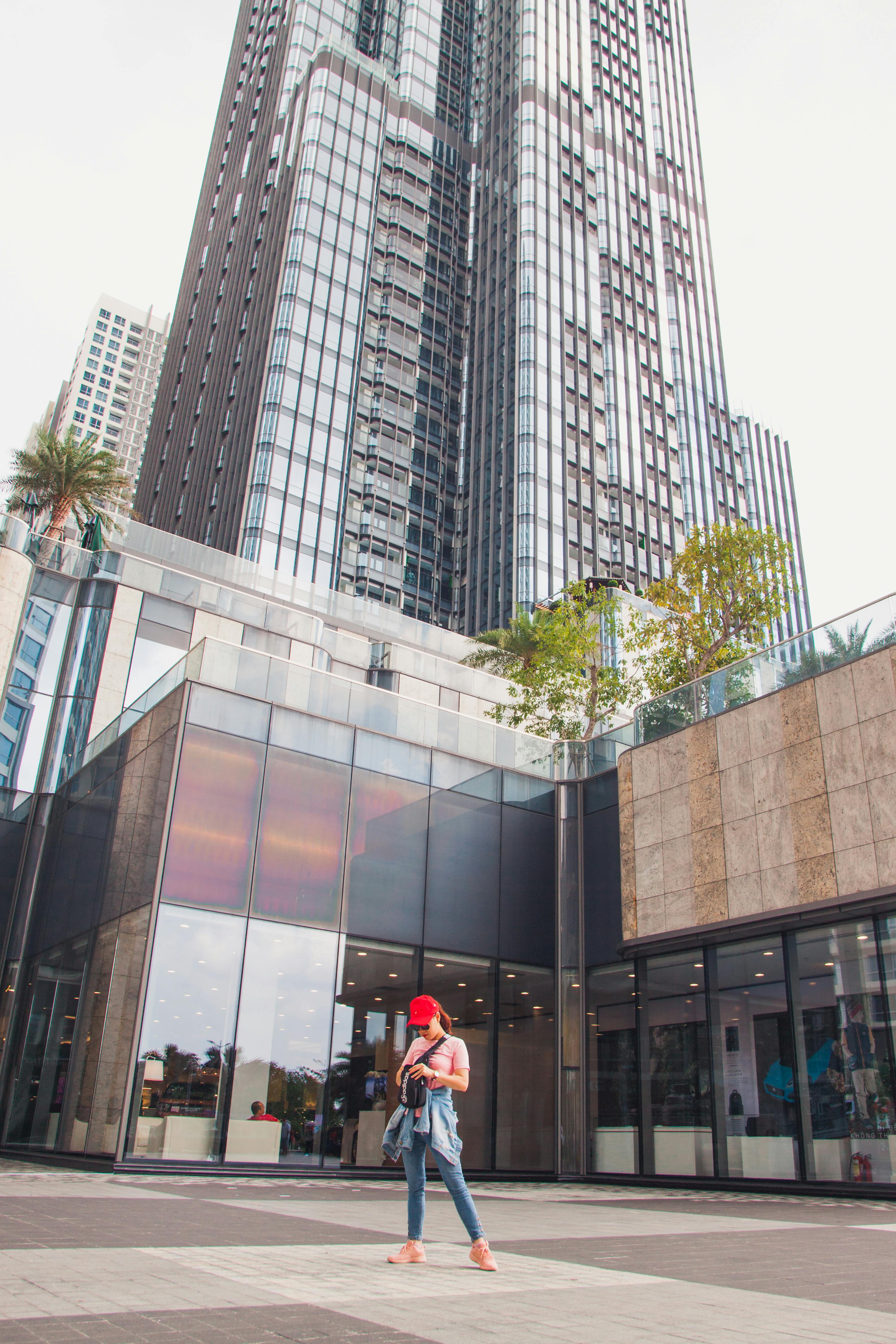 Woman Standing on Front of High-rise Building · Free Stock Photo