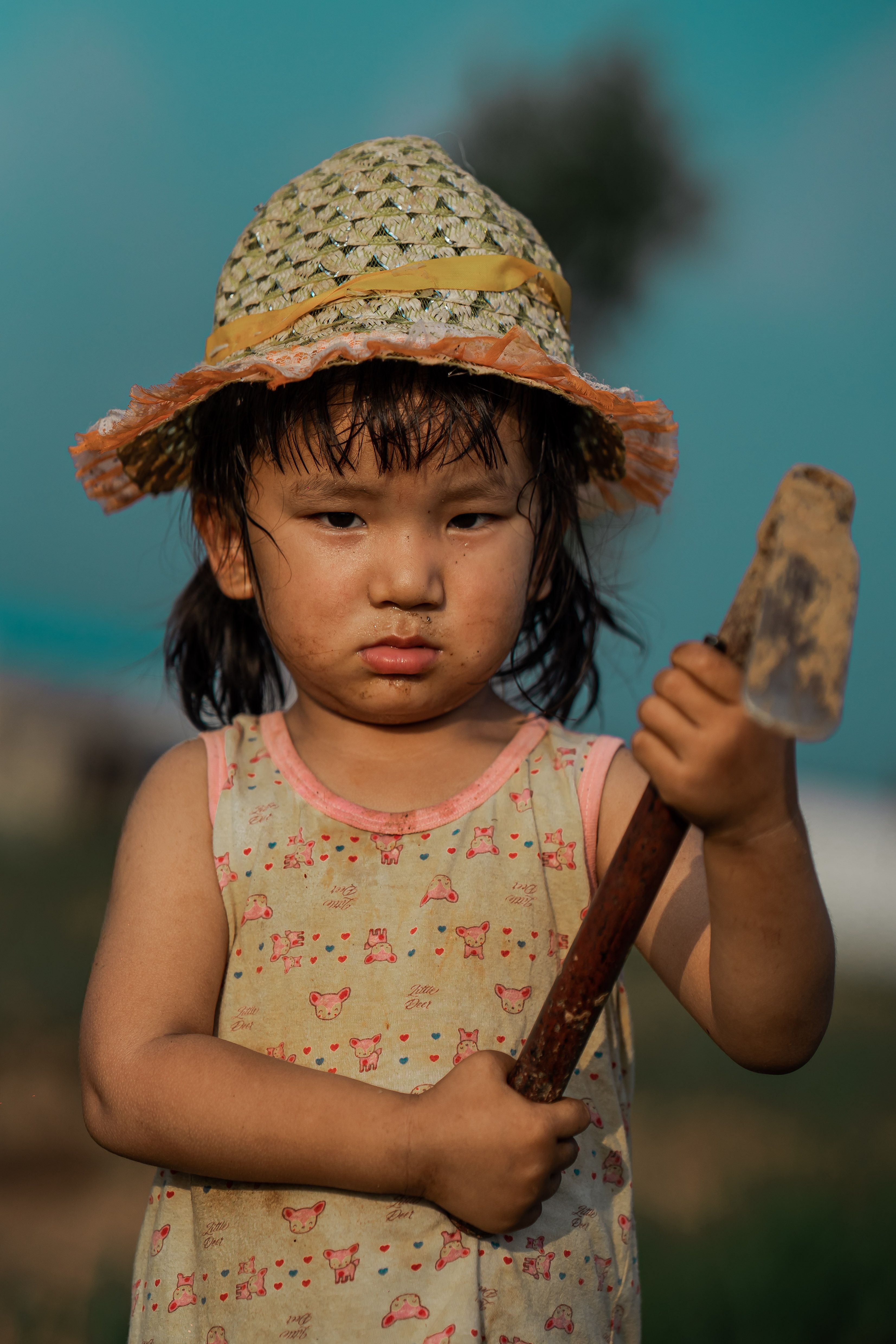 Girl in a Hat Holding a Hoe · Free Stock Photo