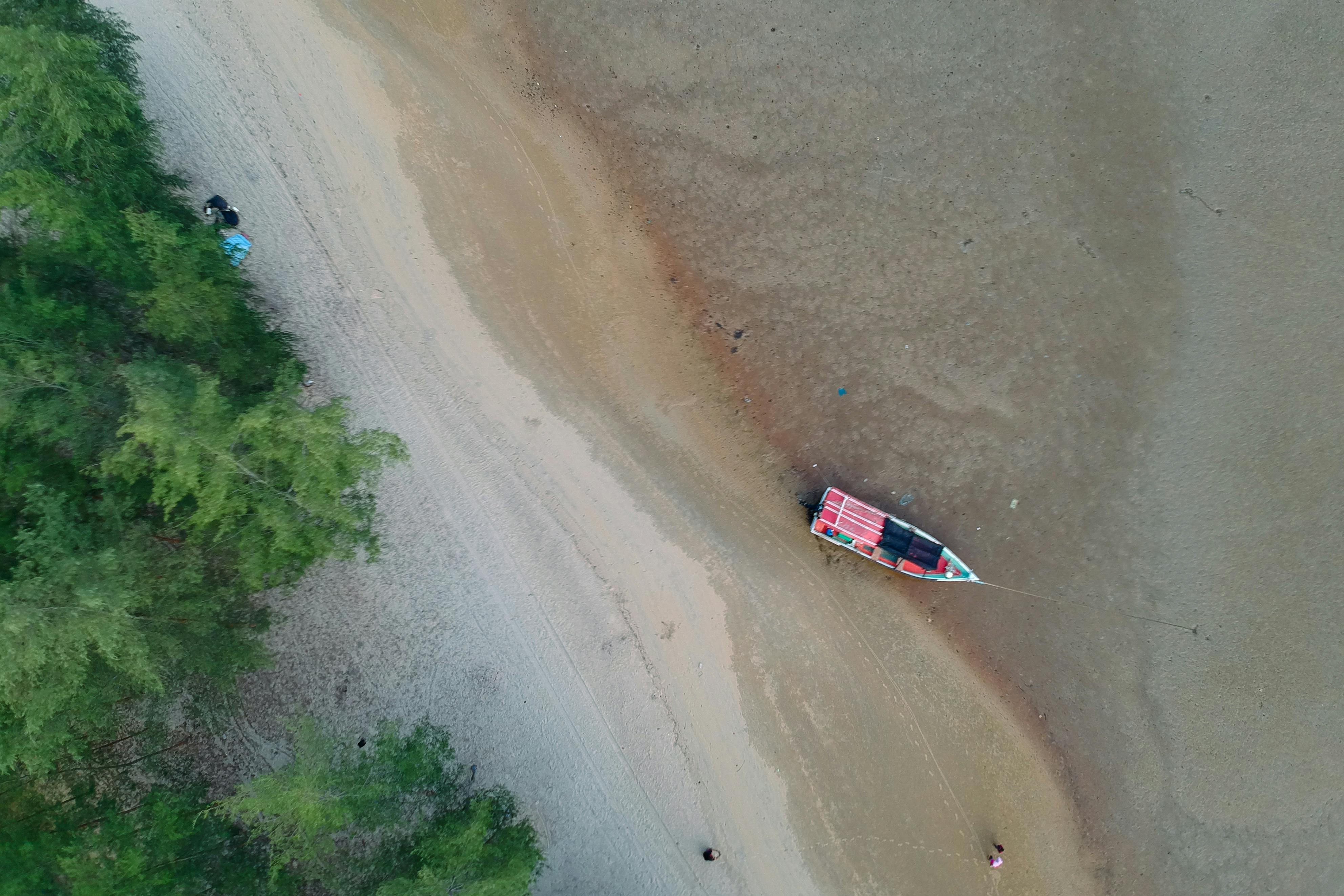Aerial View of Boat and Excavator on Shore · Free Stock Photo