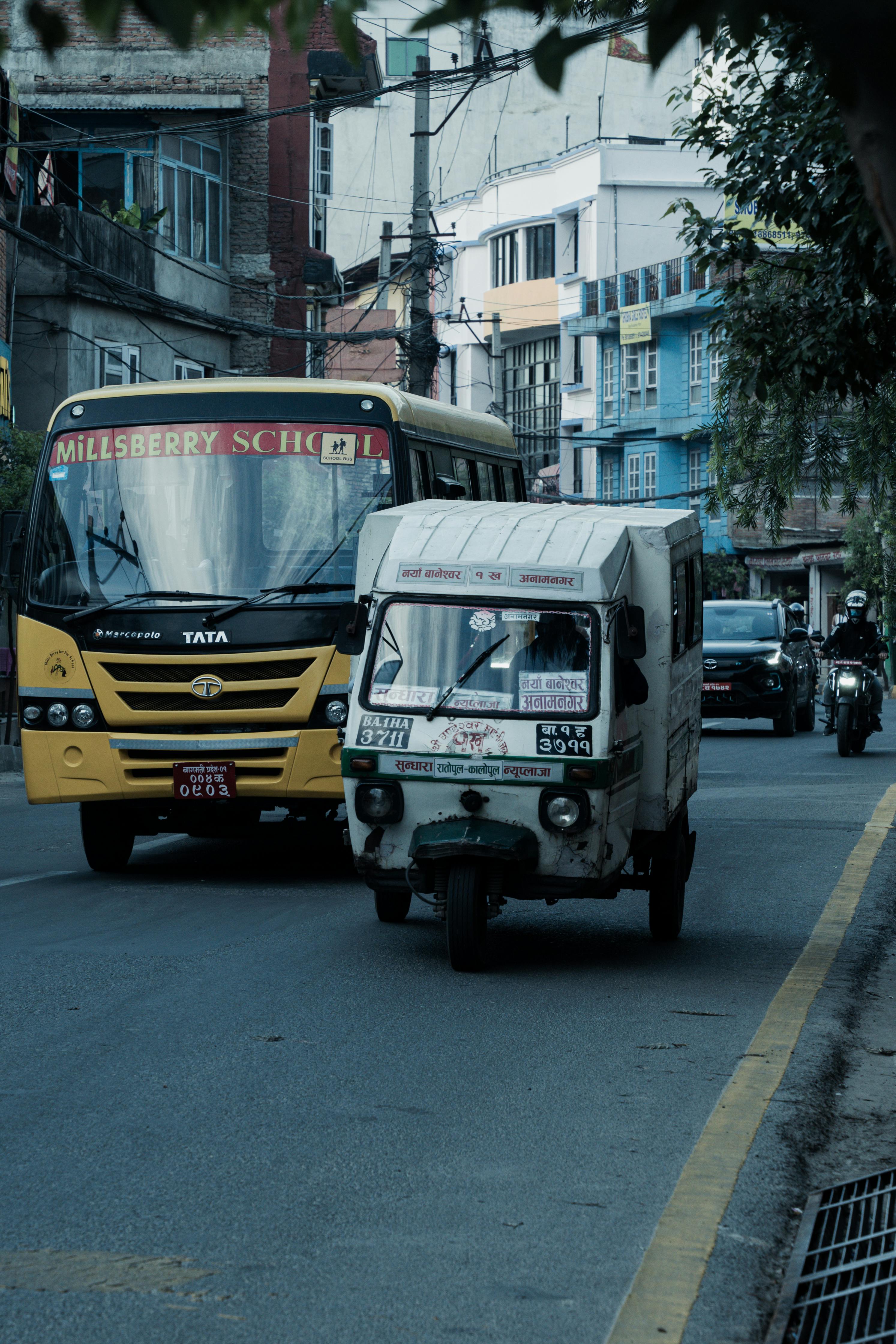 Three Wheeled Car Overtaking Bus on Street · Free Stock Photo
