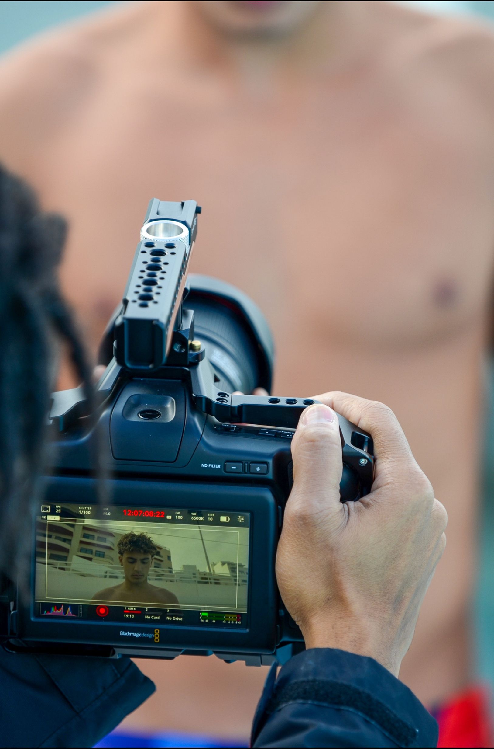 Man Photographing a Shirtless Model · Free Stock Photo