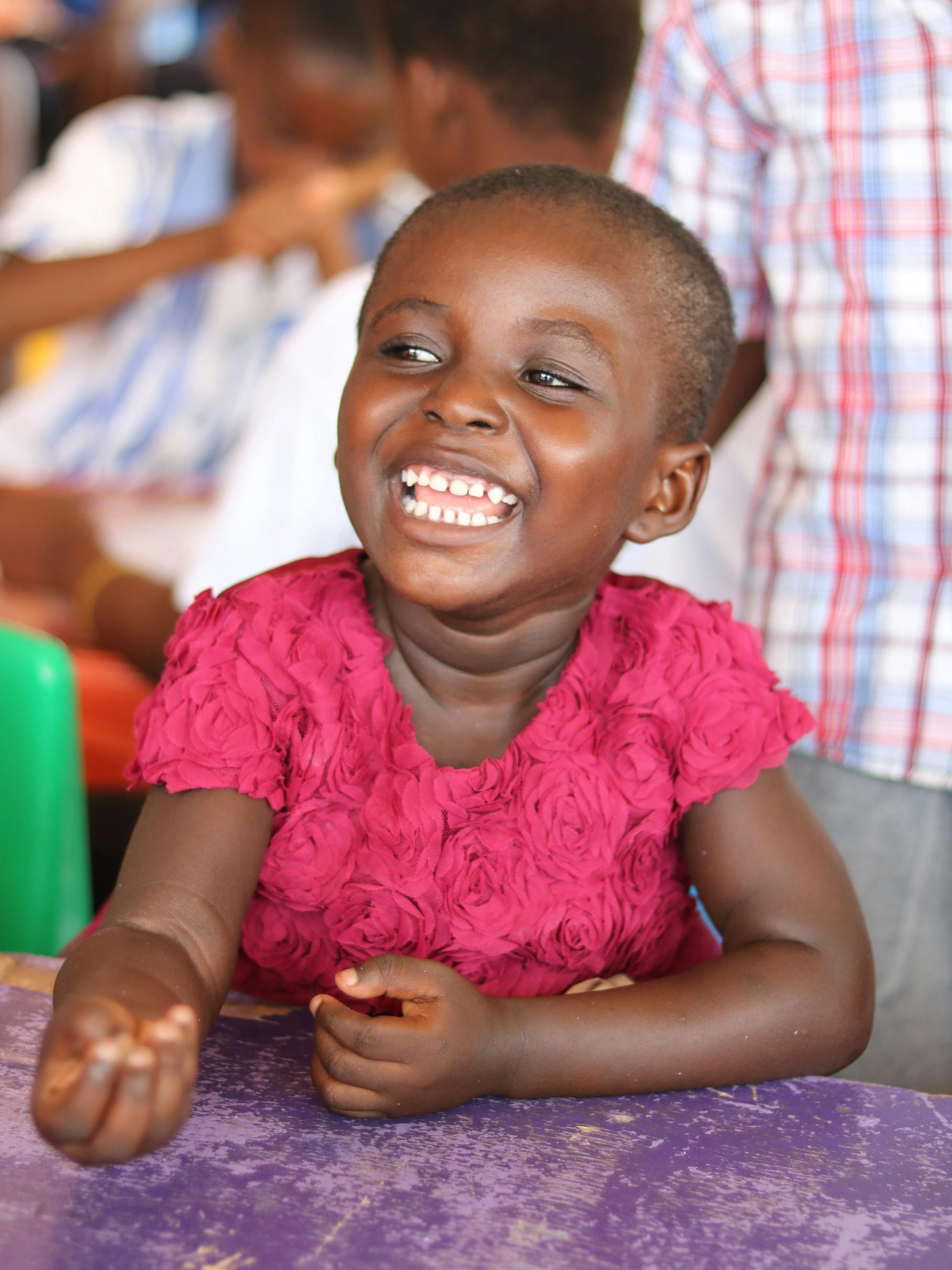 Laughing Girl in Blouse with Rose Pattern · Free Stock Photo