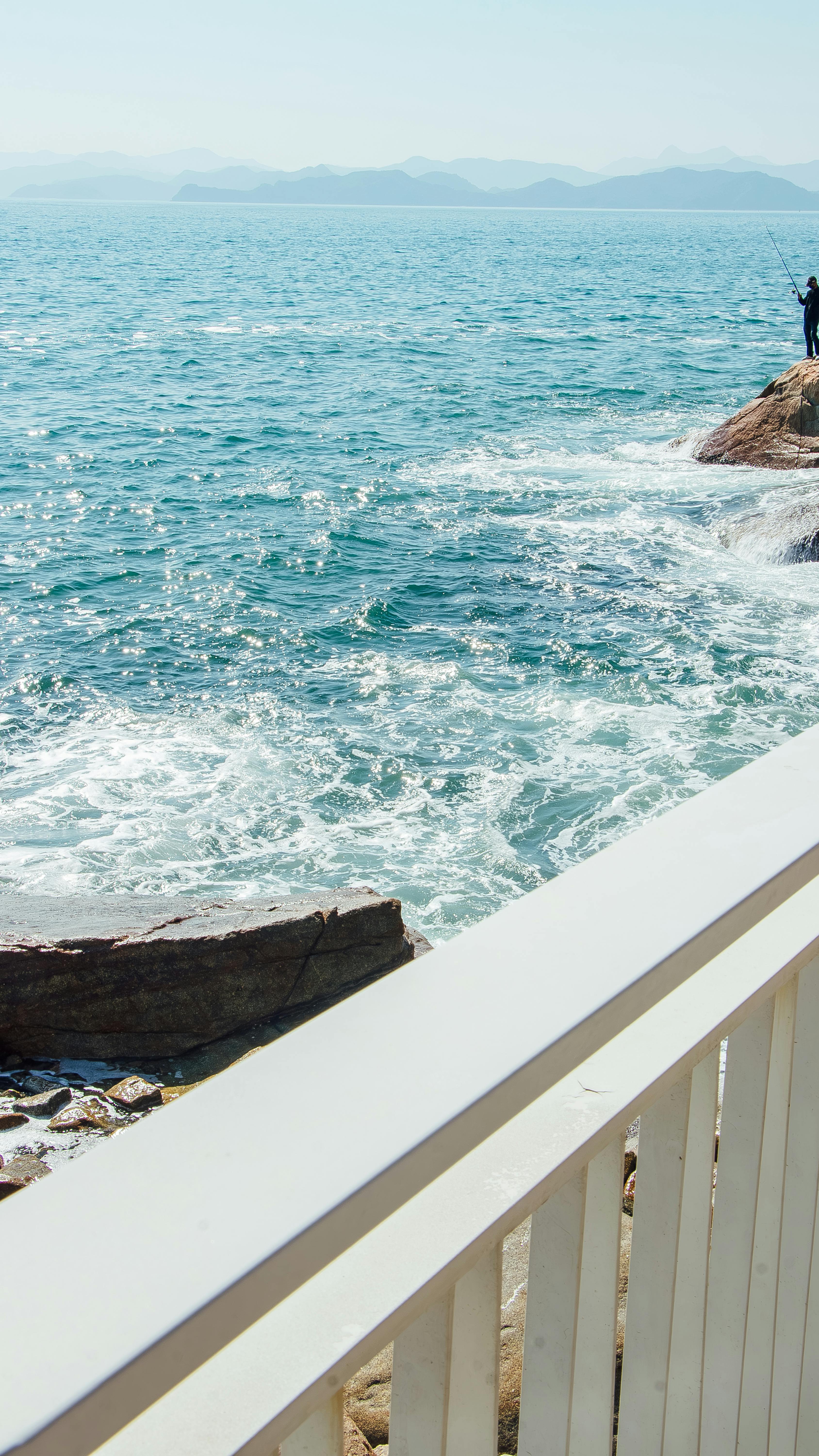 Sea Shore behind Railing · Free Stock Photo