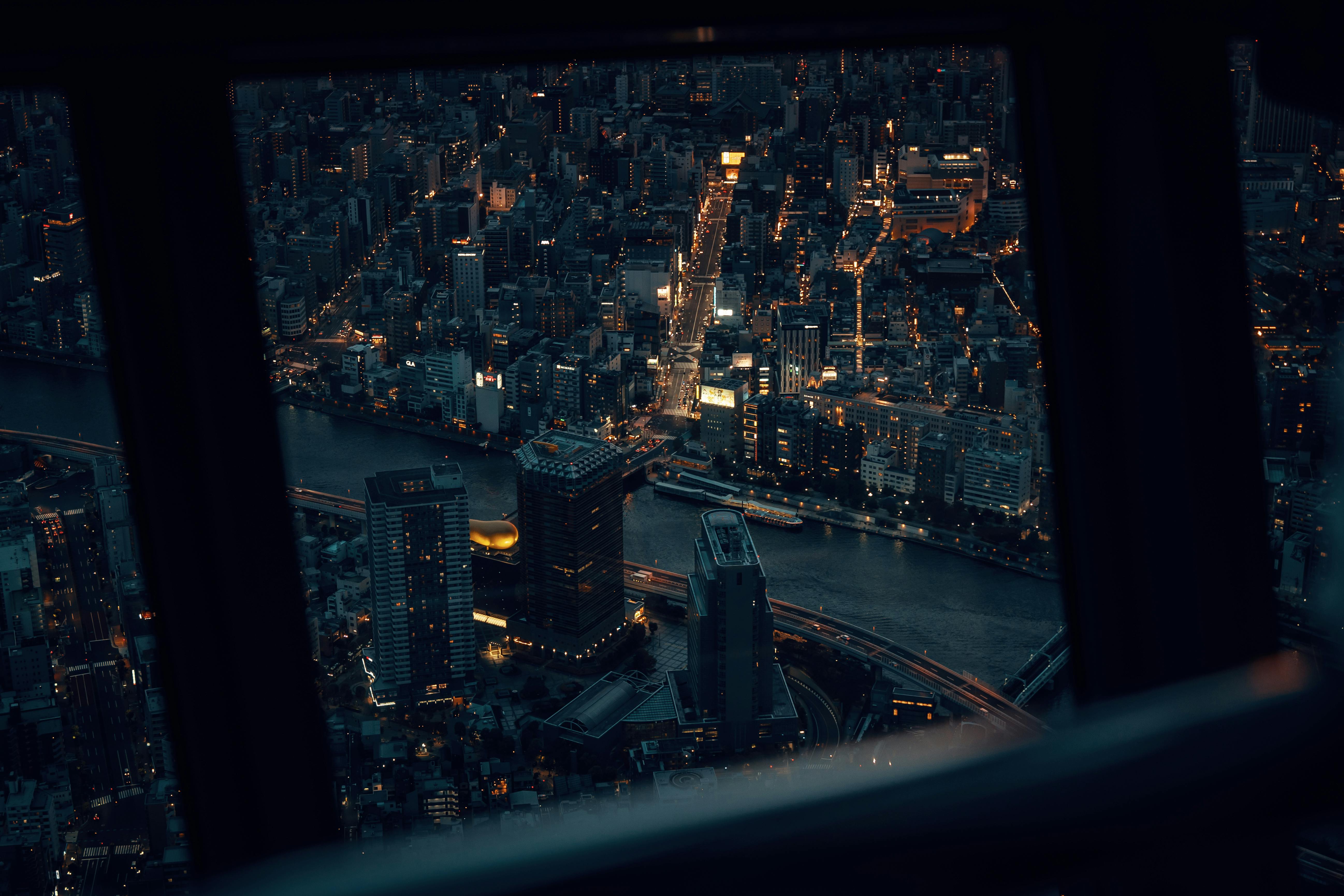 Buildings and River in City behind Window at Night · Free Stock Photo