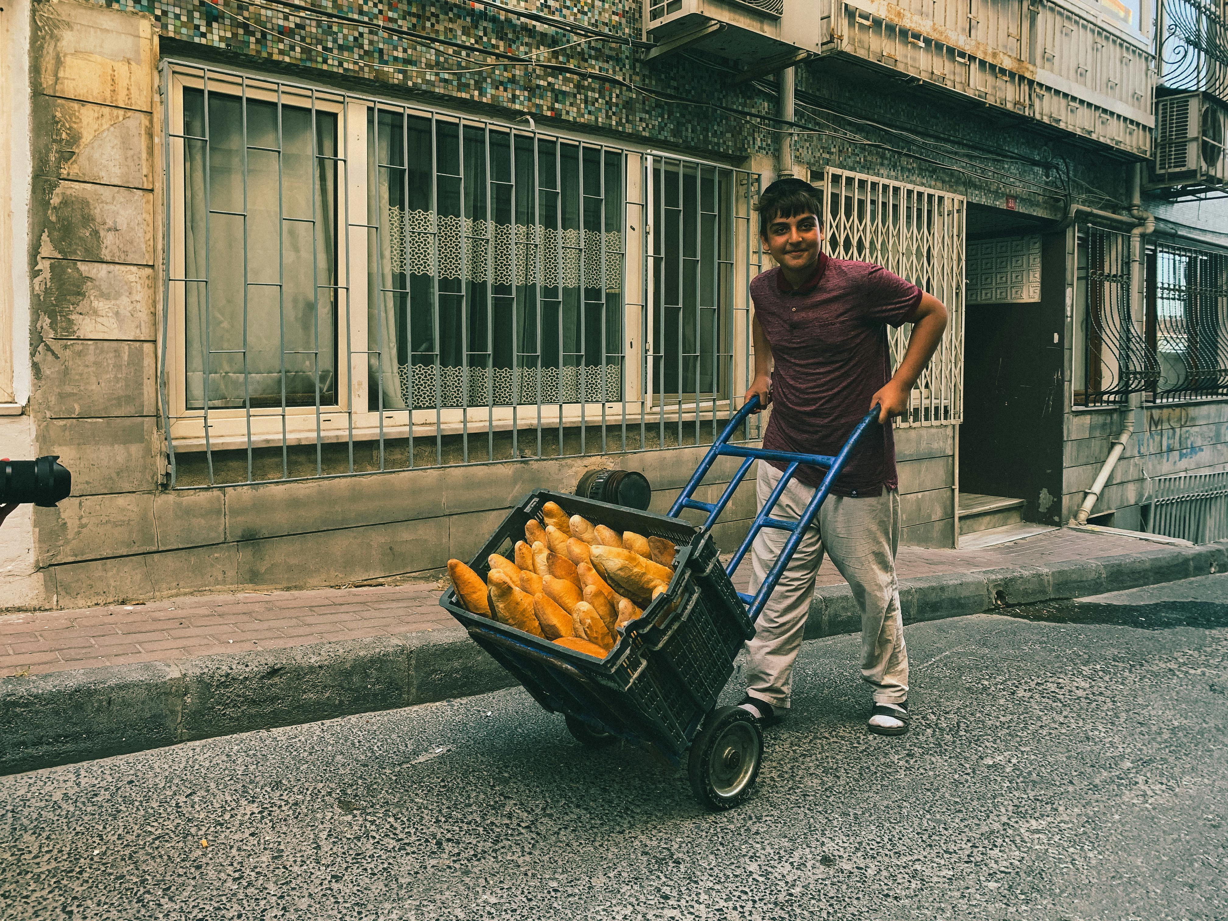 Man Carrying Baguettes in a Trolley · Free Stock Photo