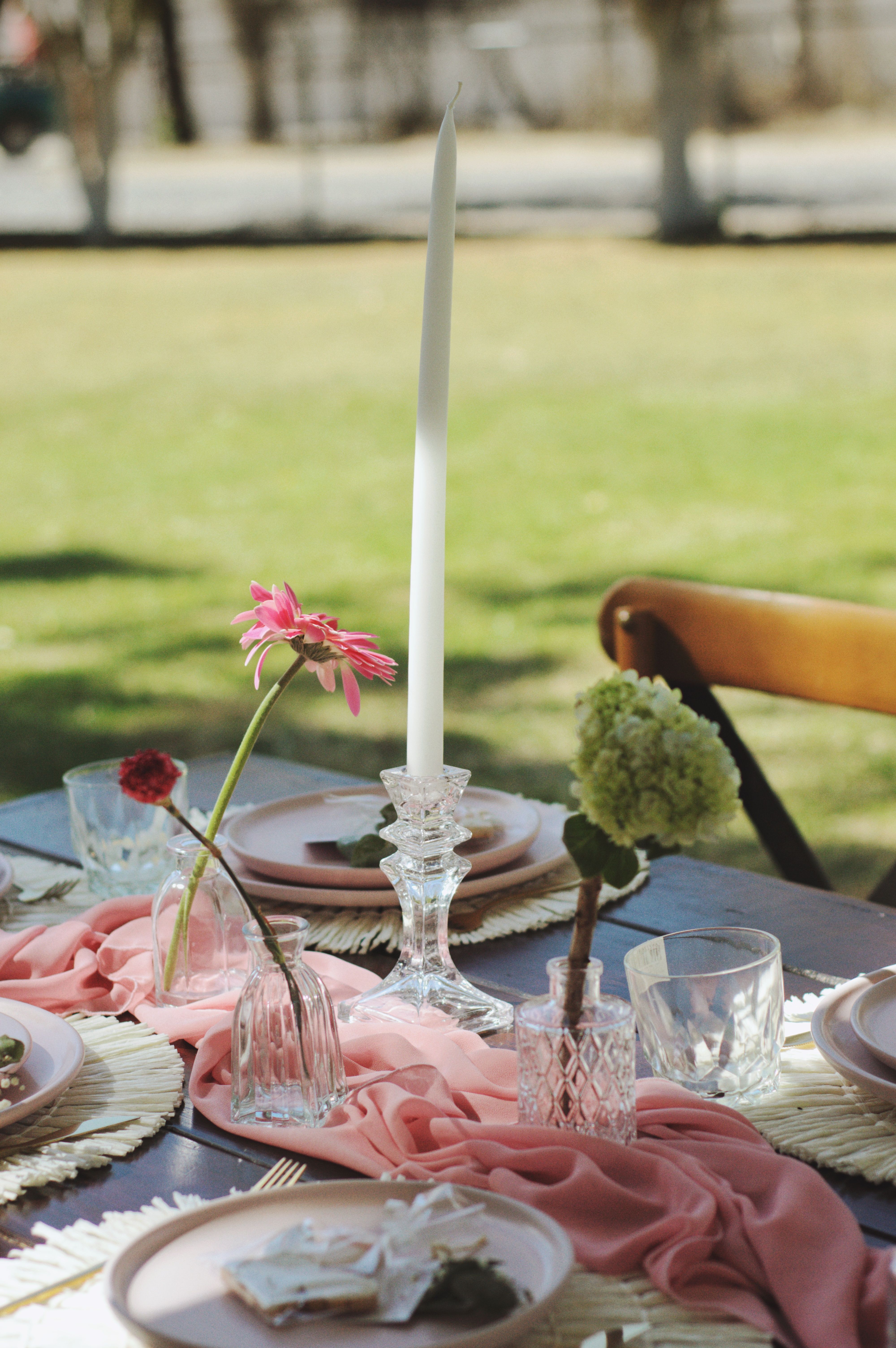 Candle and Flowers in Middle of Table in Garden · Free Stock Photo
