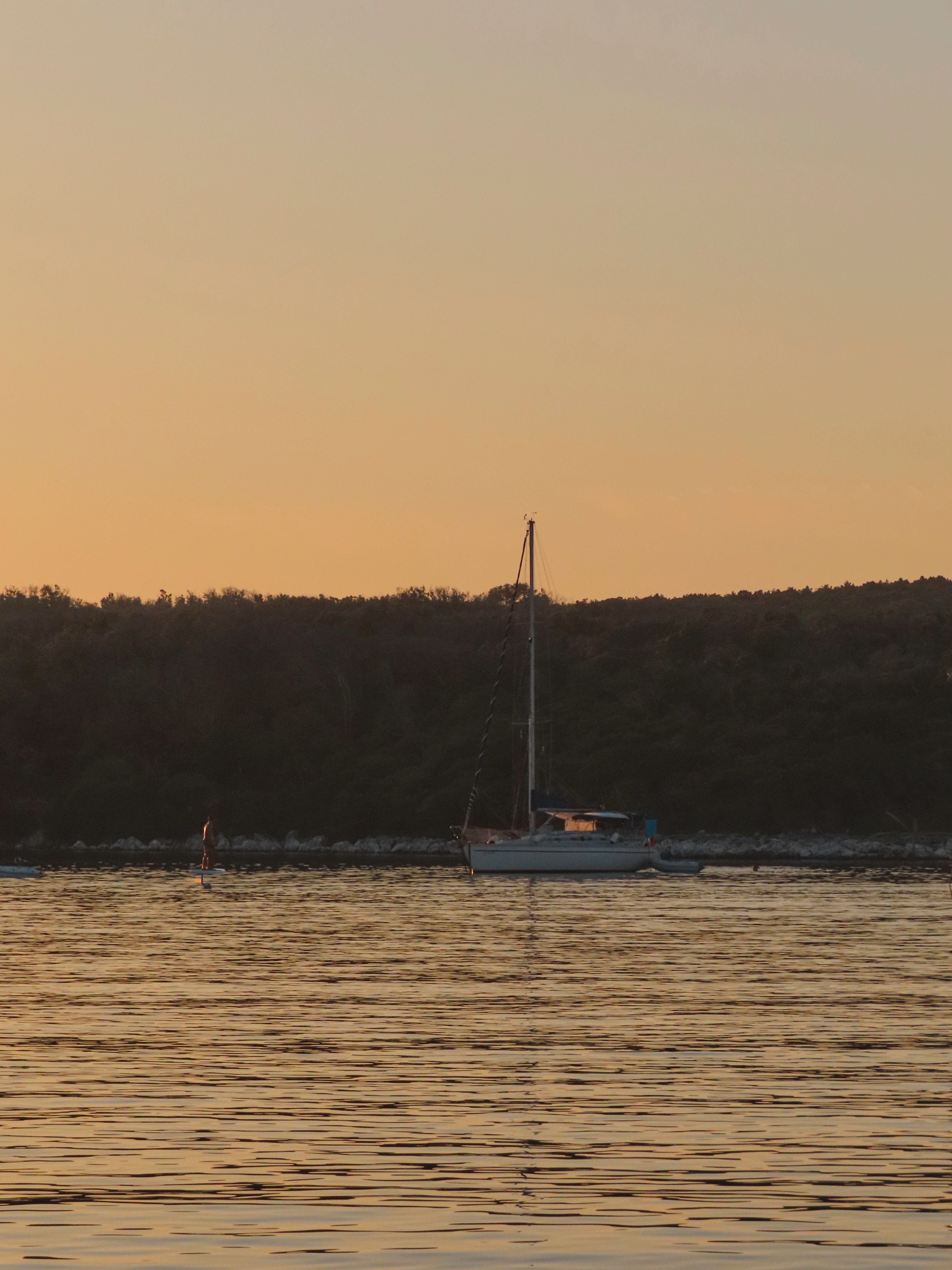Lone Sailboat at the Coast at Dusk · Free Stock Photo