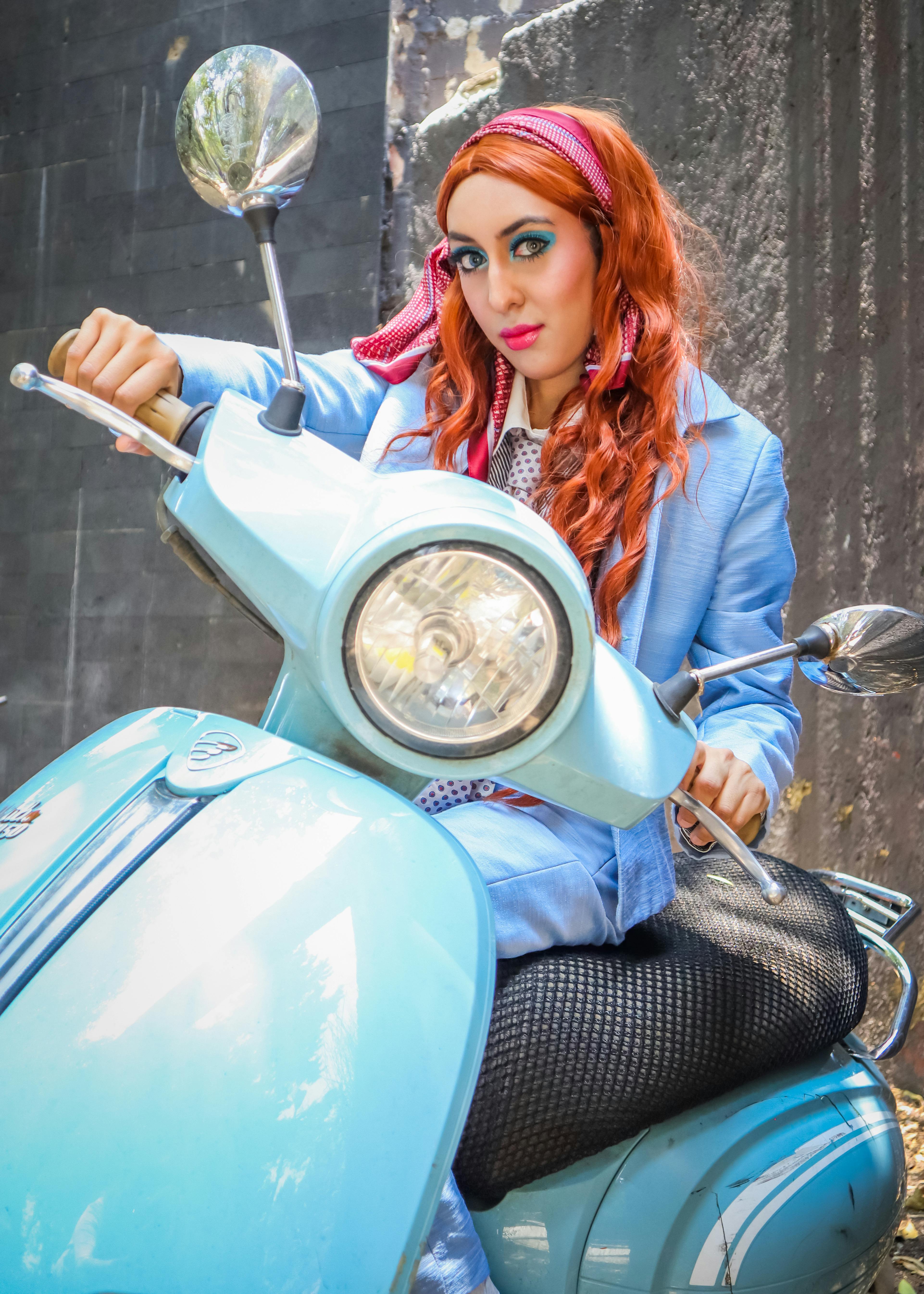 A Young Redhead Sitting on a Motor Scooter · Free Stock Photo