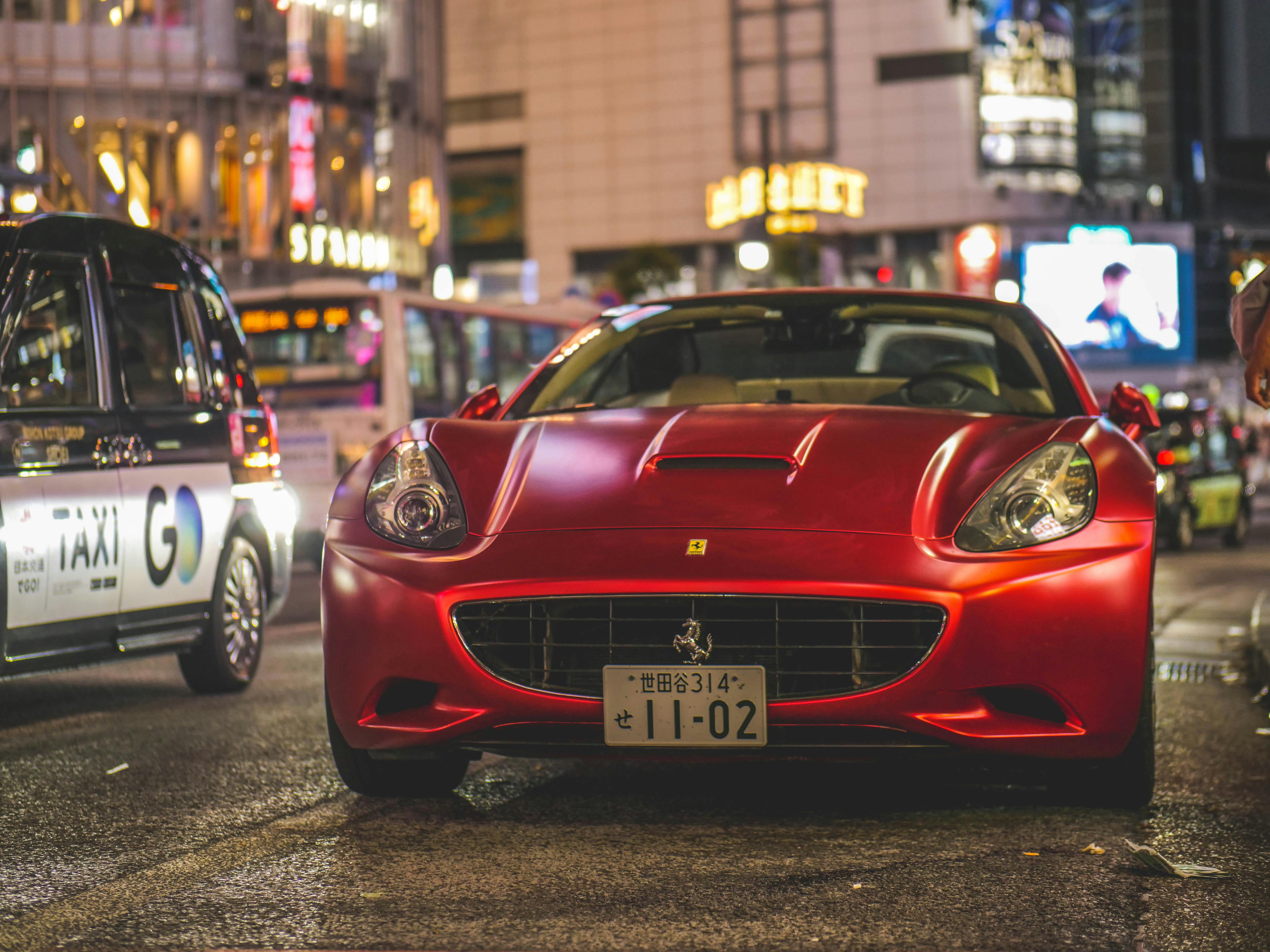 Ferrari California Driving in a City at Night · Free Stock Photo