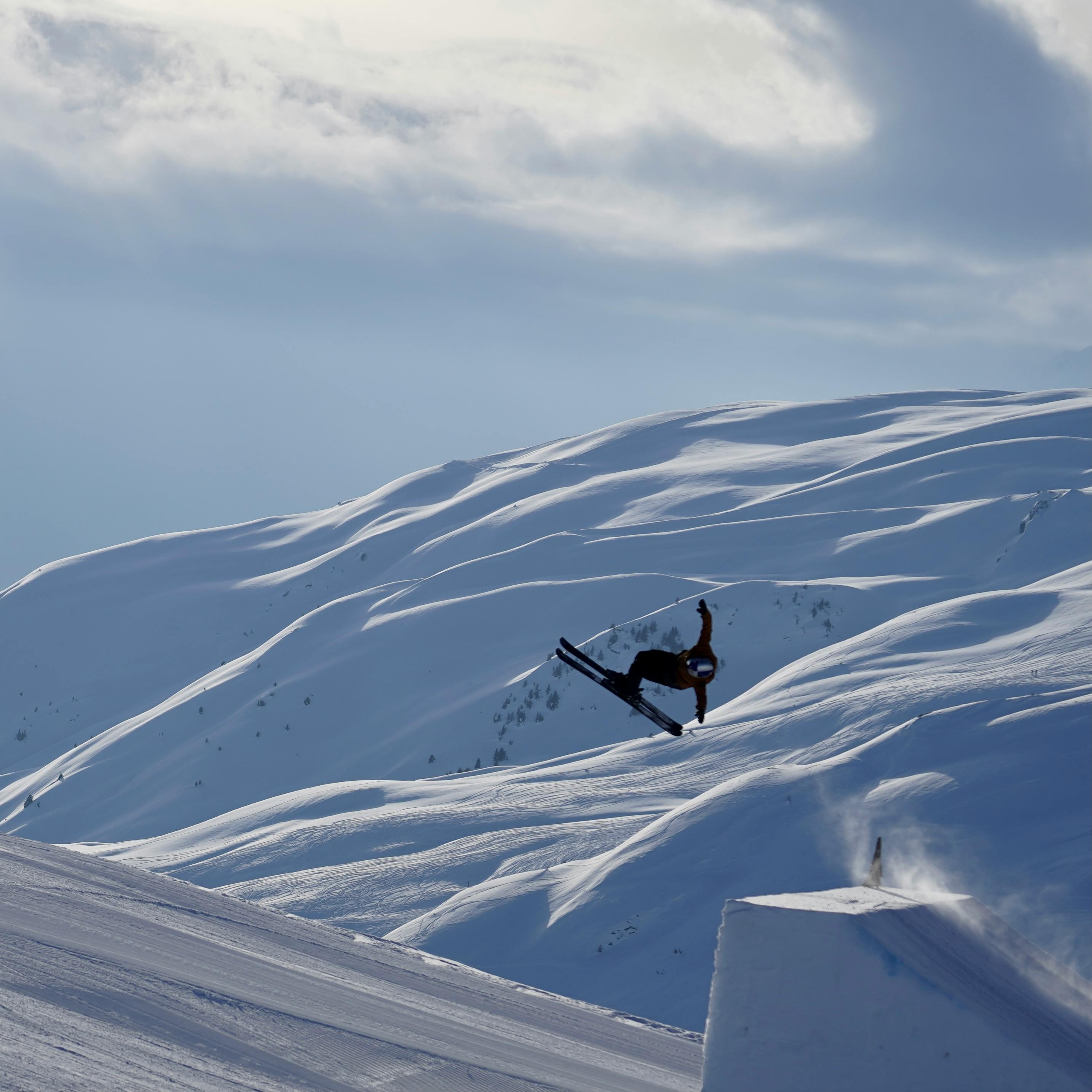 Photo of a Person Jumping while Skiing on the Slope · Free Stock Photo
