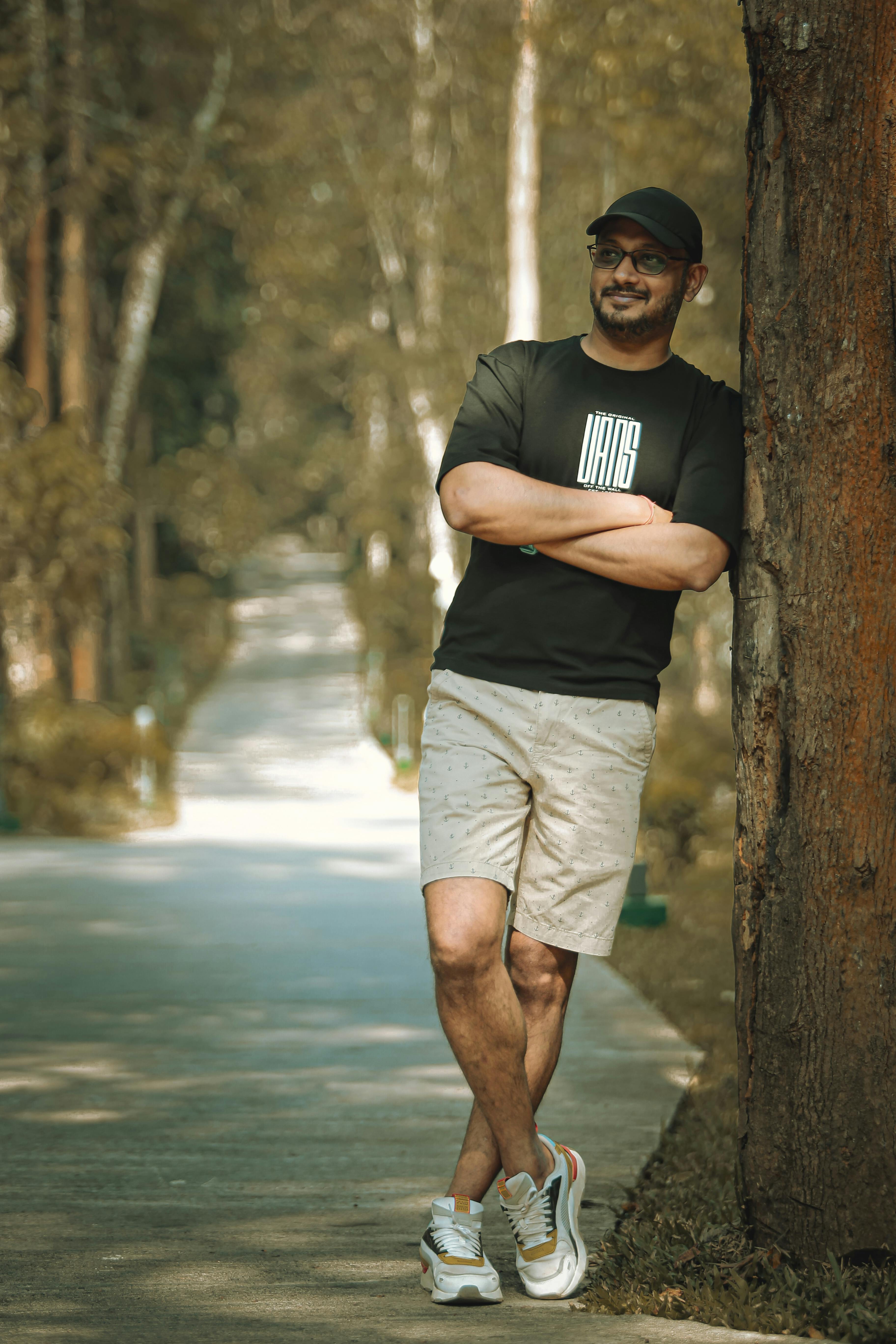 Brunette Man in Cap on Road in Forest · Free Stock Photo