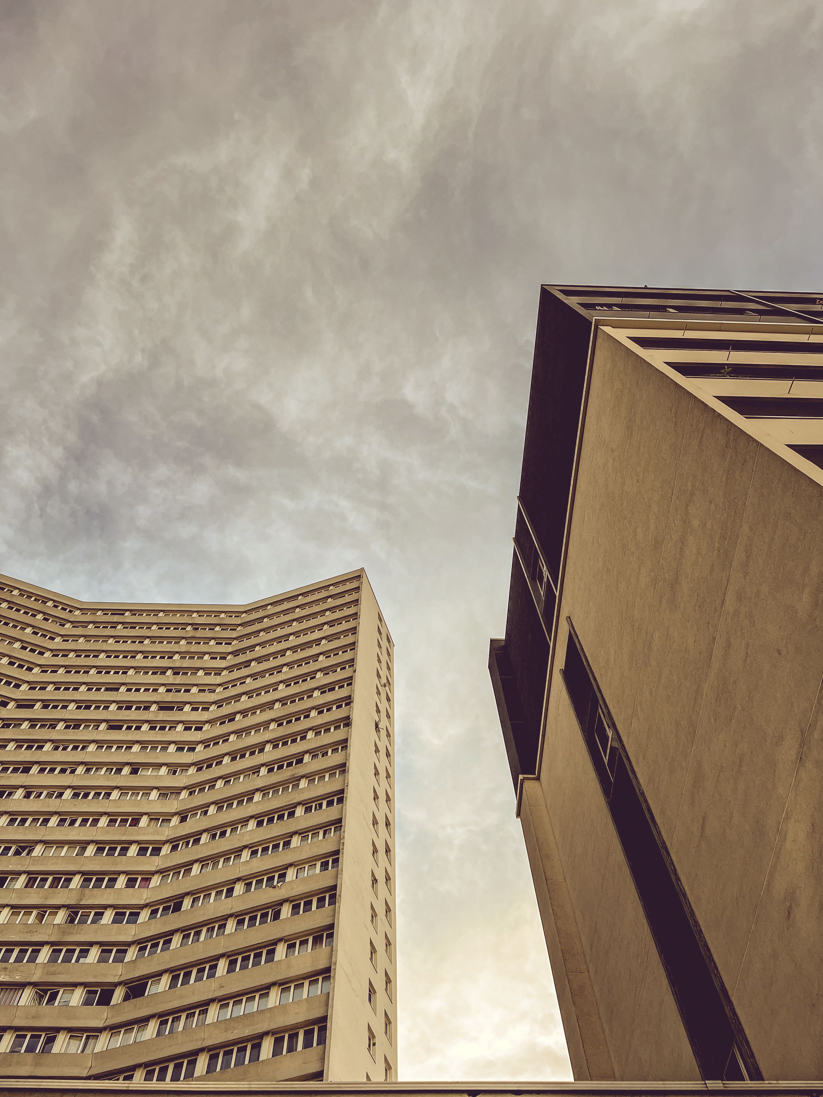Cloudy Sky over Apartment Buildings in City · Free Stock Photo