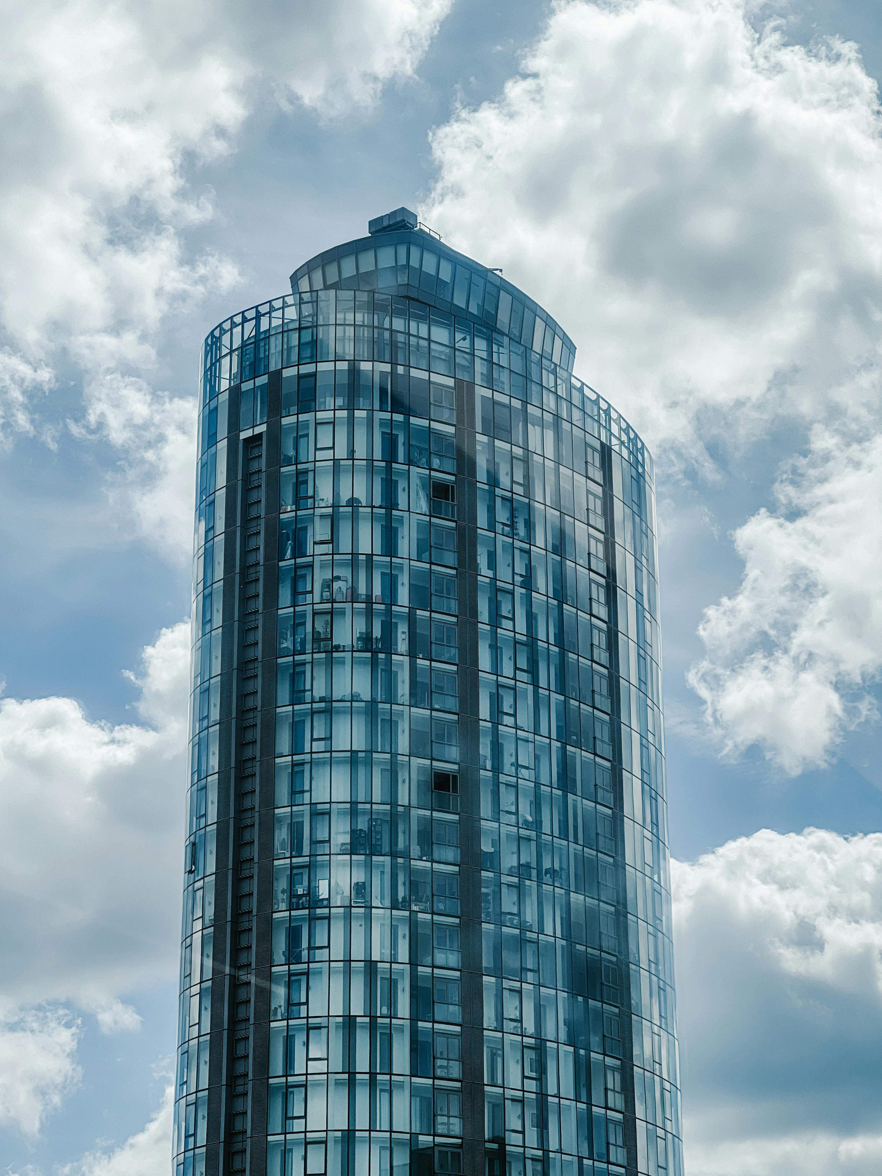 Modern Glass Building against Sky with Clouds · Free Stock Photo