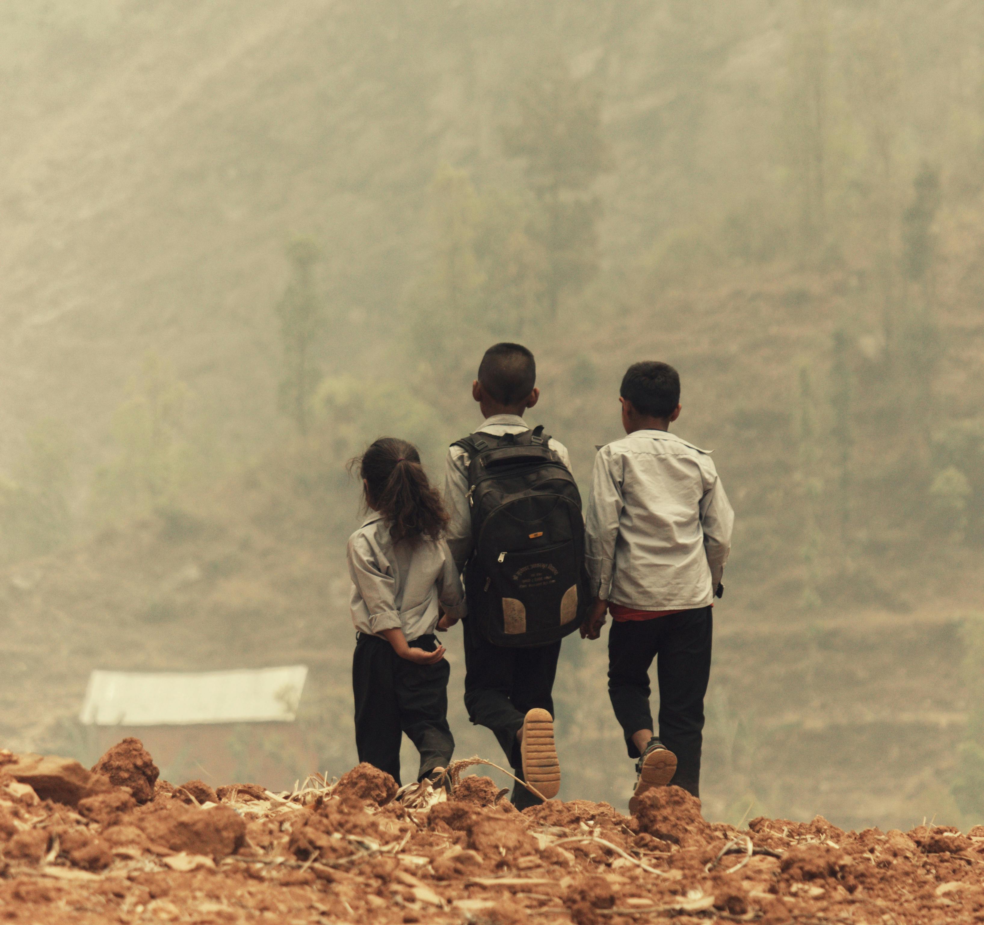Three Children Walking Side by Side · Free Stock Photo