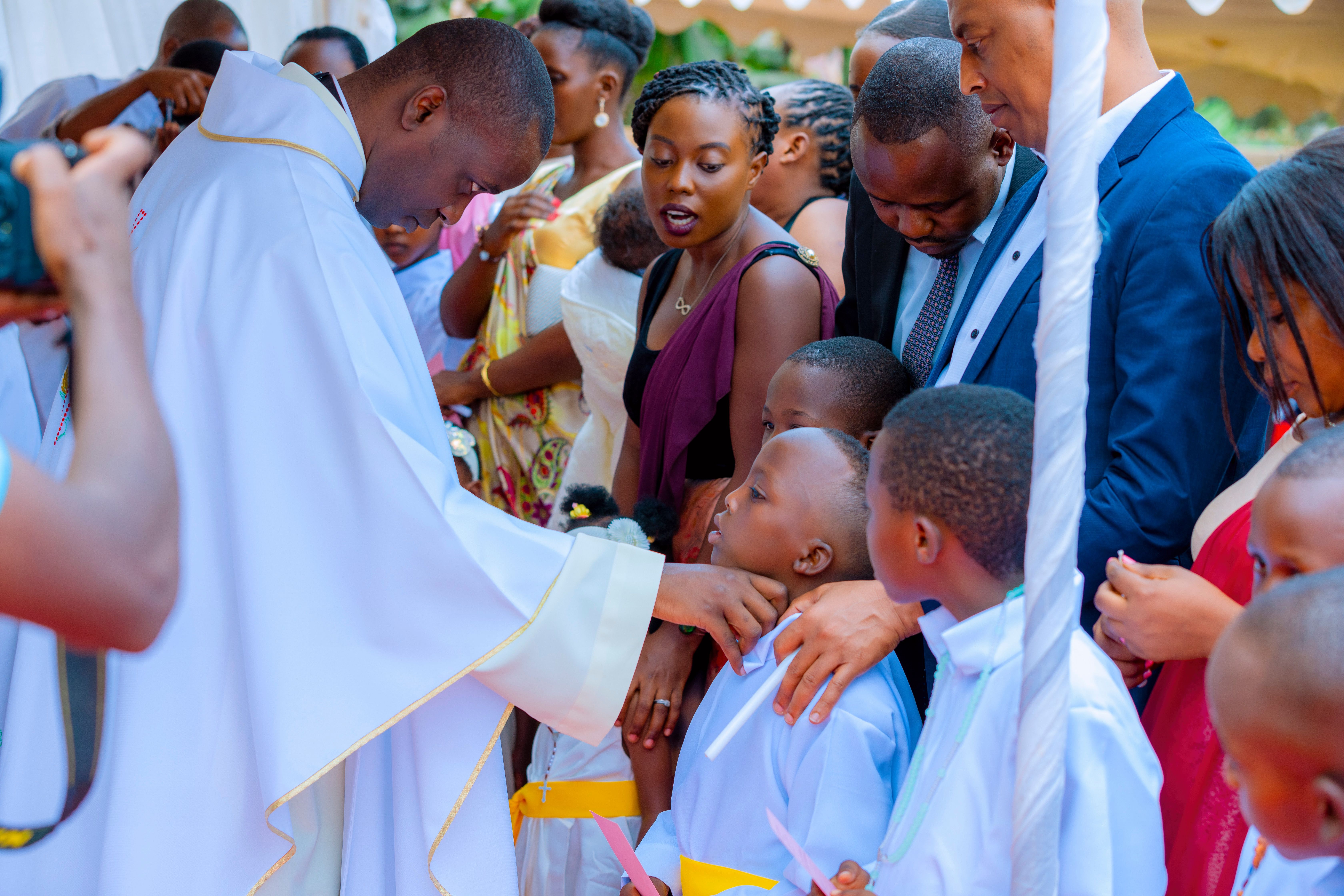A priest is blessing children at a church · Free Stock Photo