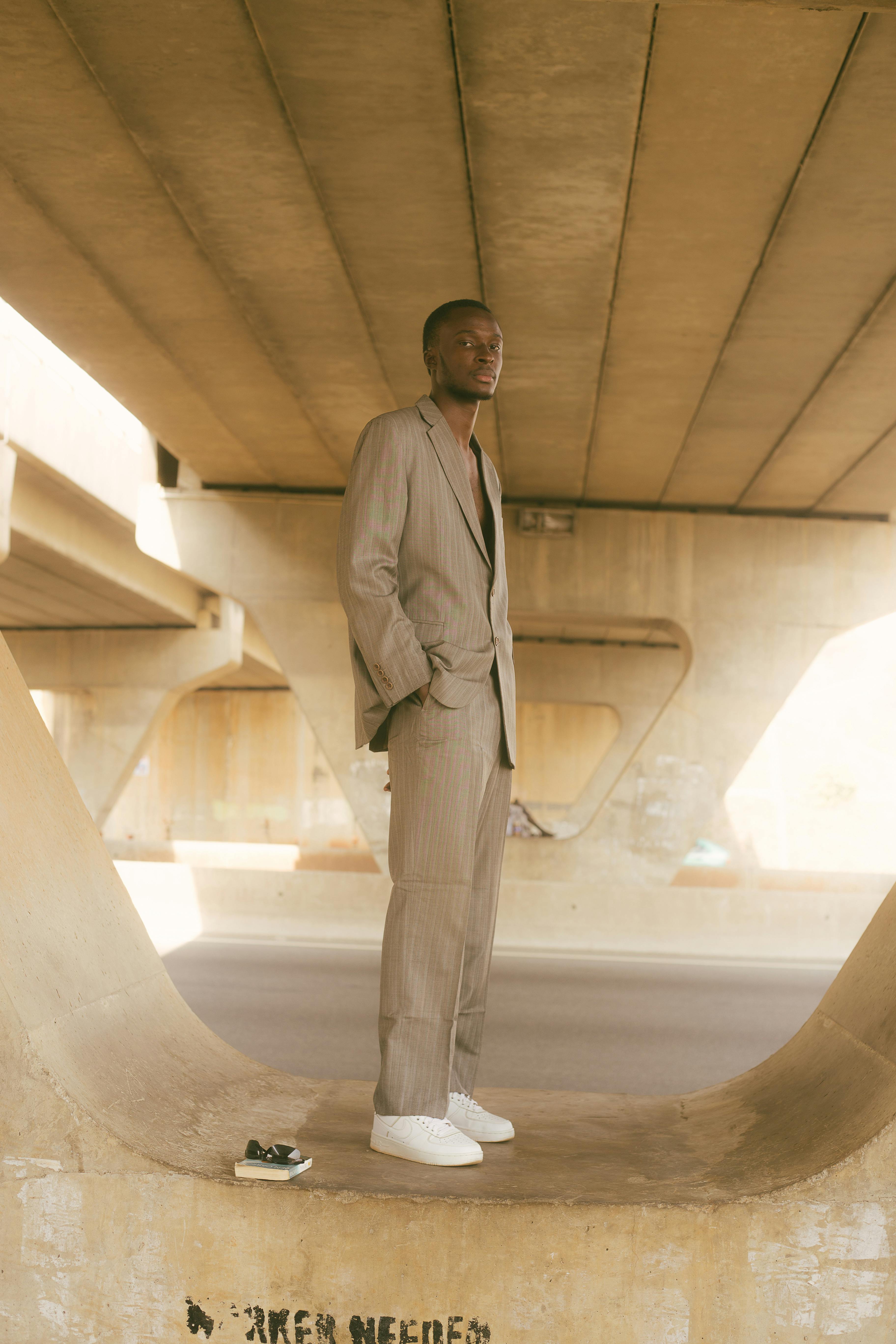 Man Posing in a Suit under a Bridge · Free Stock Photo